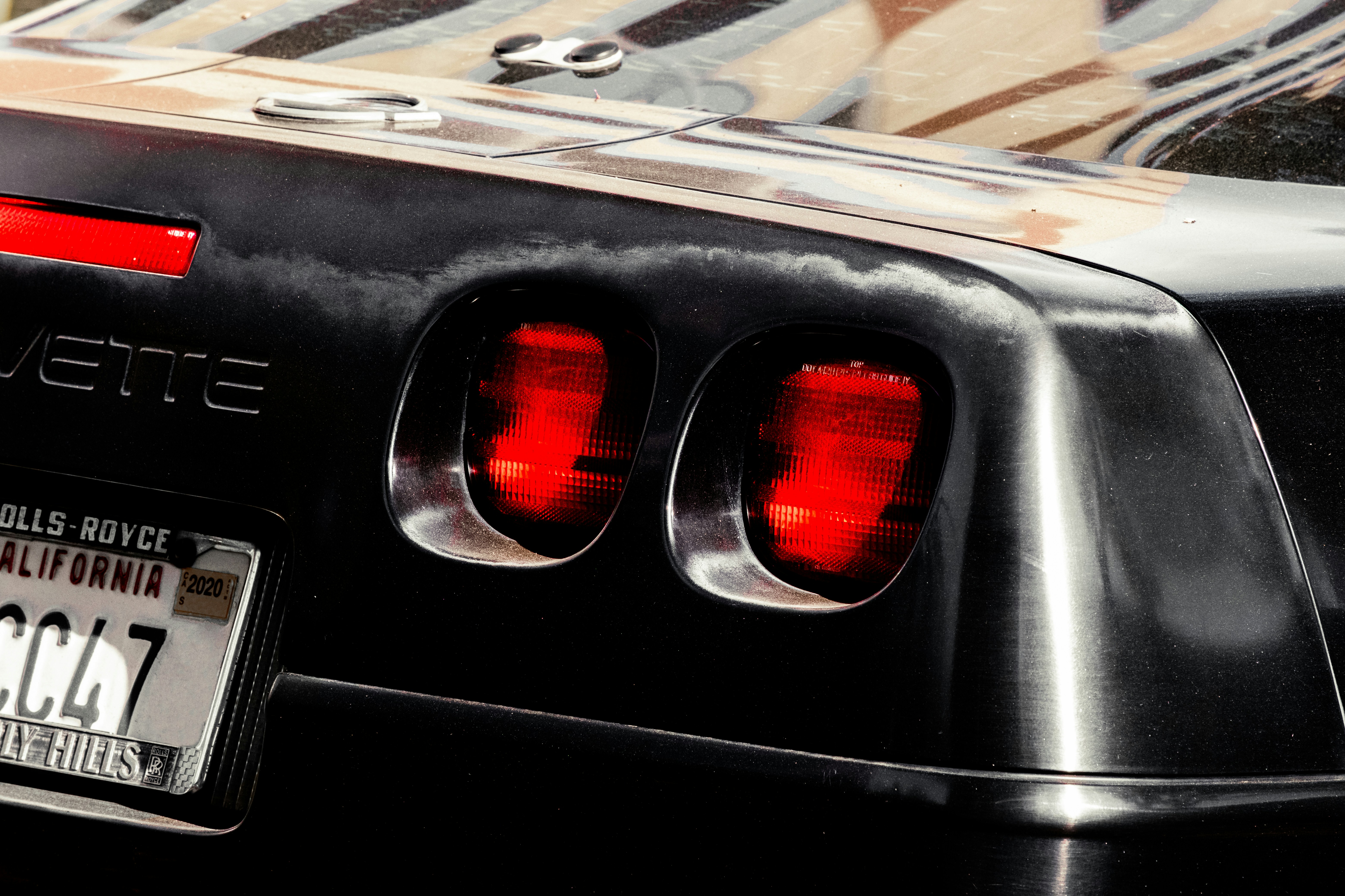 Tail lights and taillight chrome: a rear view of a Chevrolet Corvette at dusk
