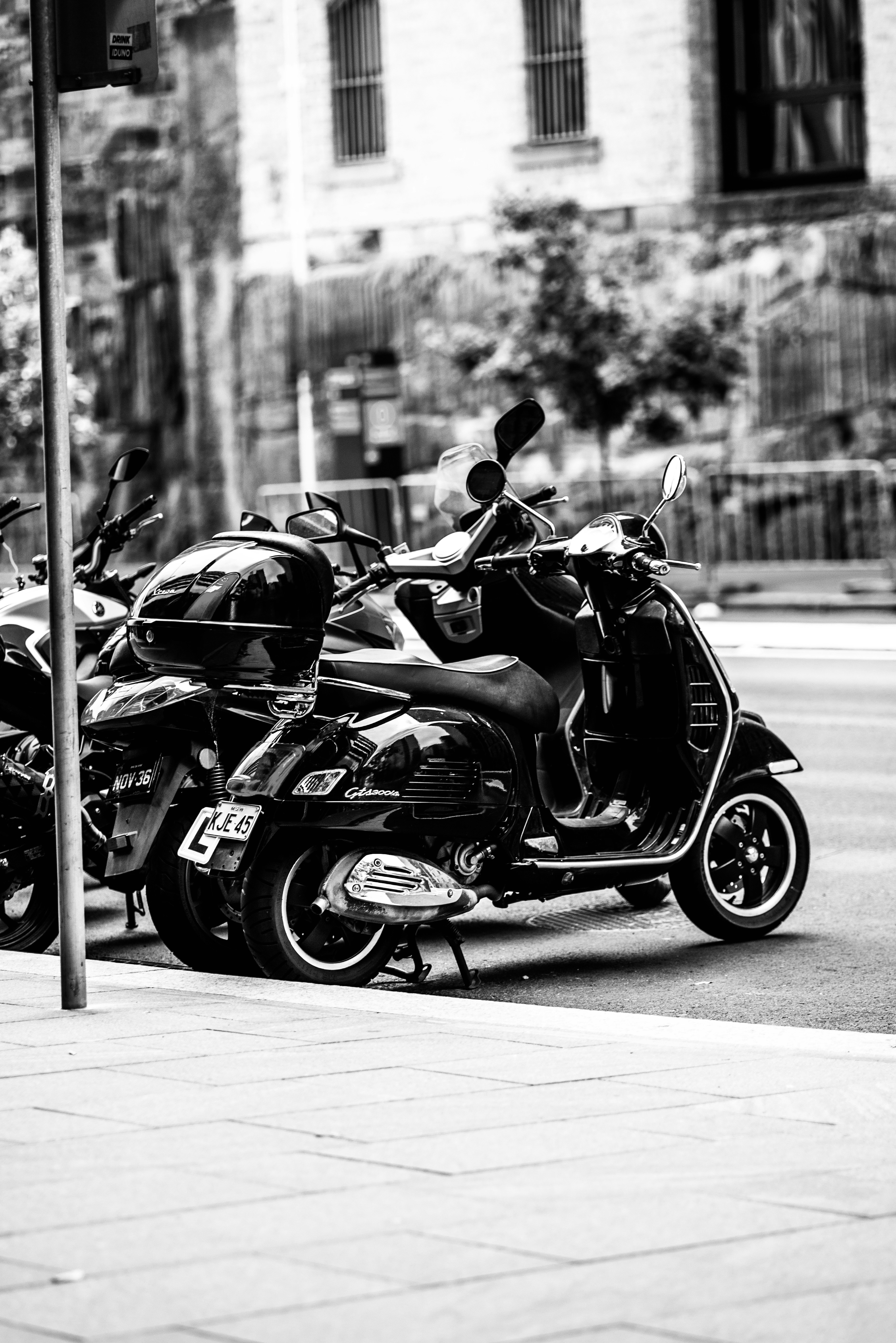 Chrome Echoes: A Quiet Row of Parked Scooters in Monochrome