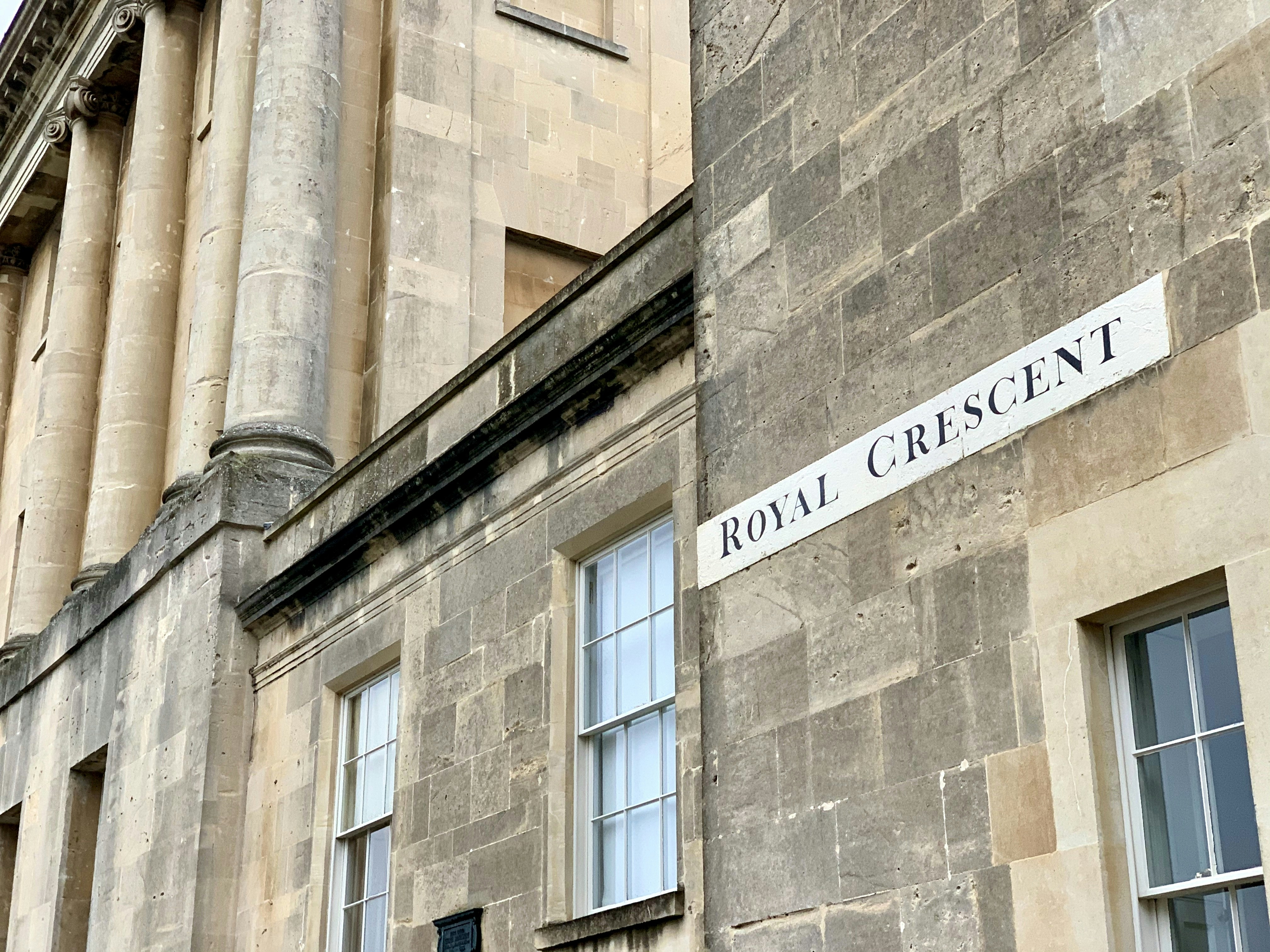 Historic stone building with tall columns and a sign reading 'Royal Crescent'.