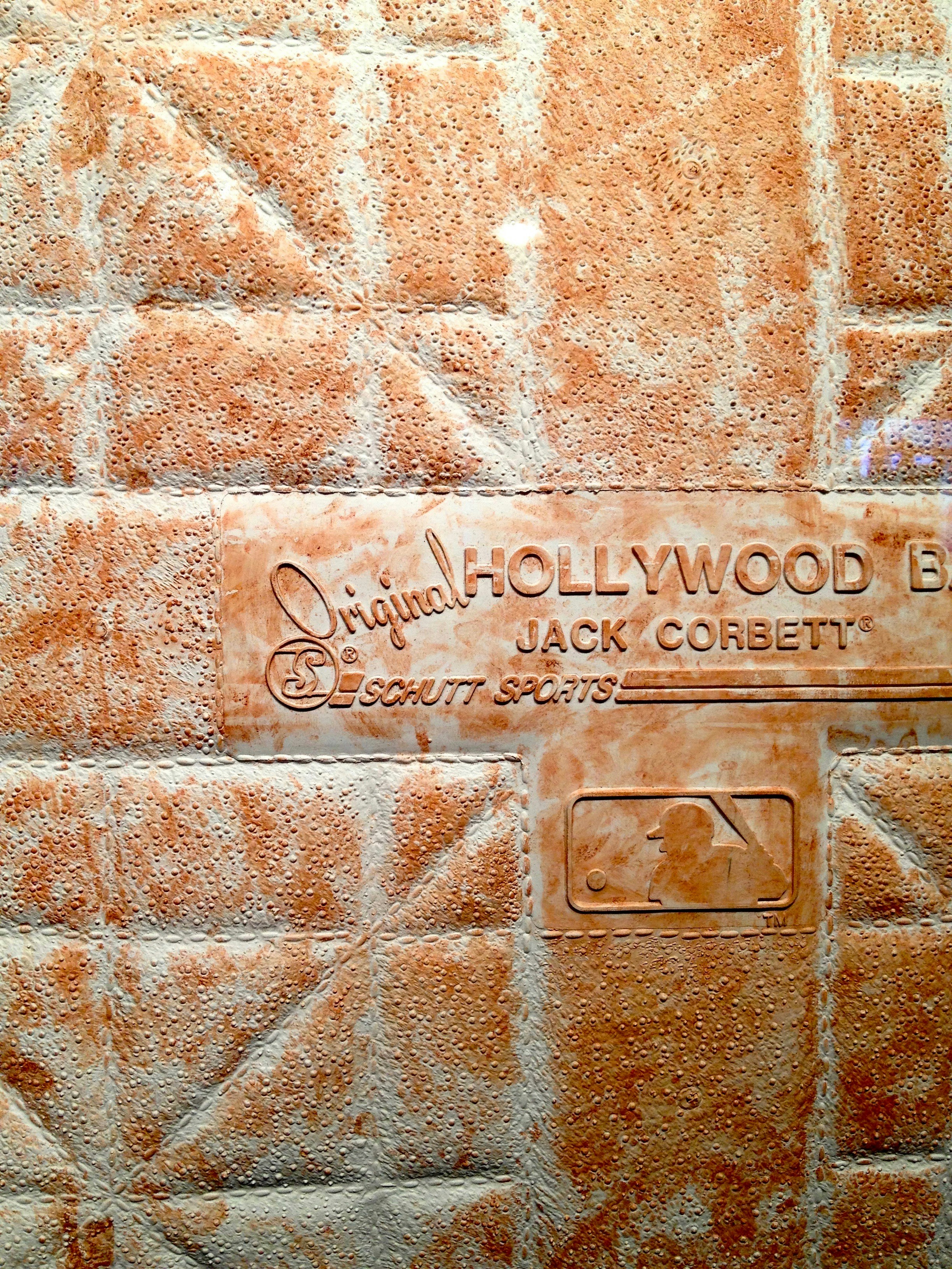 Engraved plaque commemorating Jack Corbett's Original Hollywood Baseball, featuring a baseball icon and intricate textures.