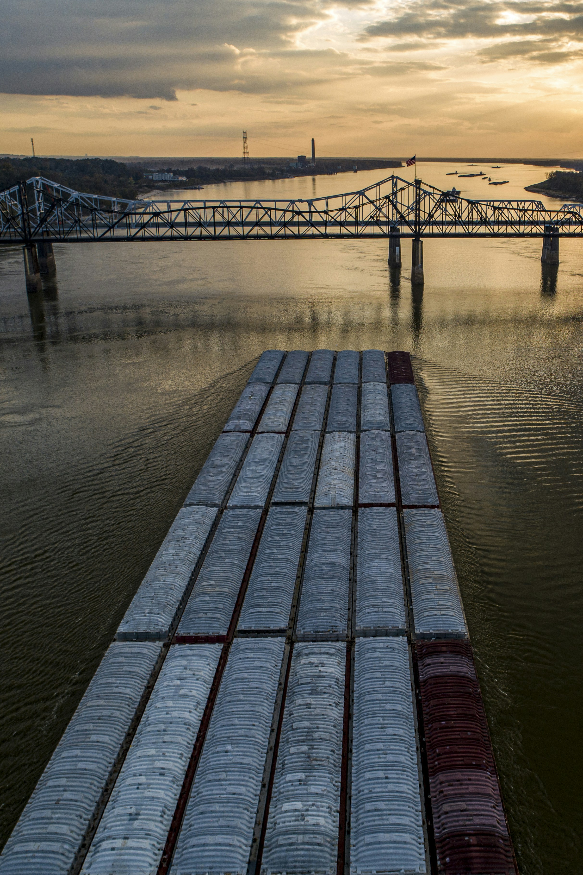Line of Barrels at Dusk: A River Crossing's Quiet Convergence