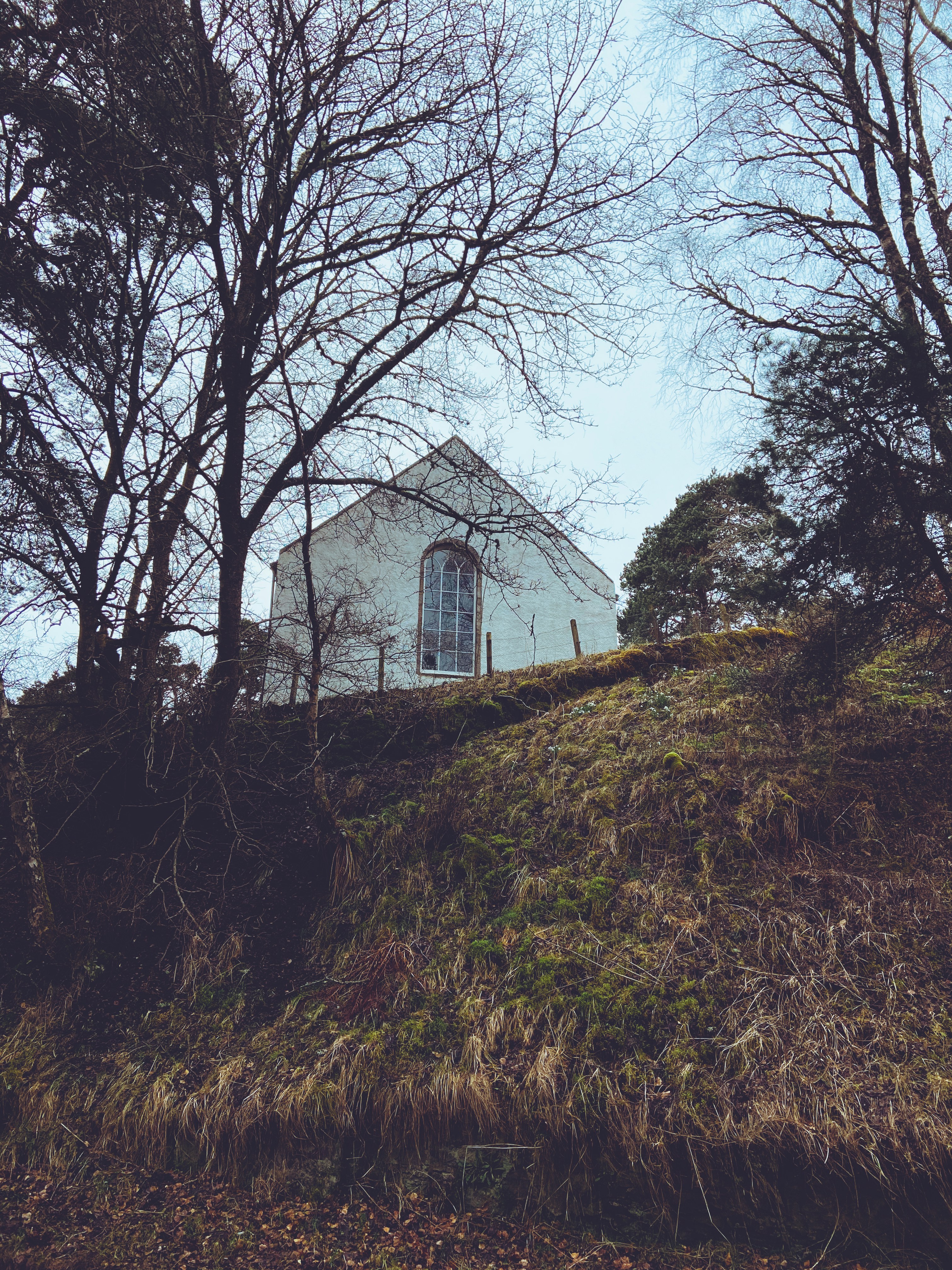 Hilltop Chapel Framed by Winter Branches