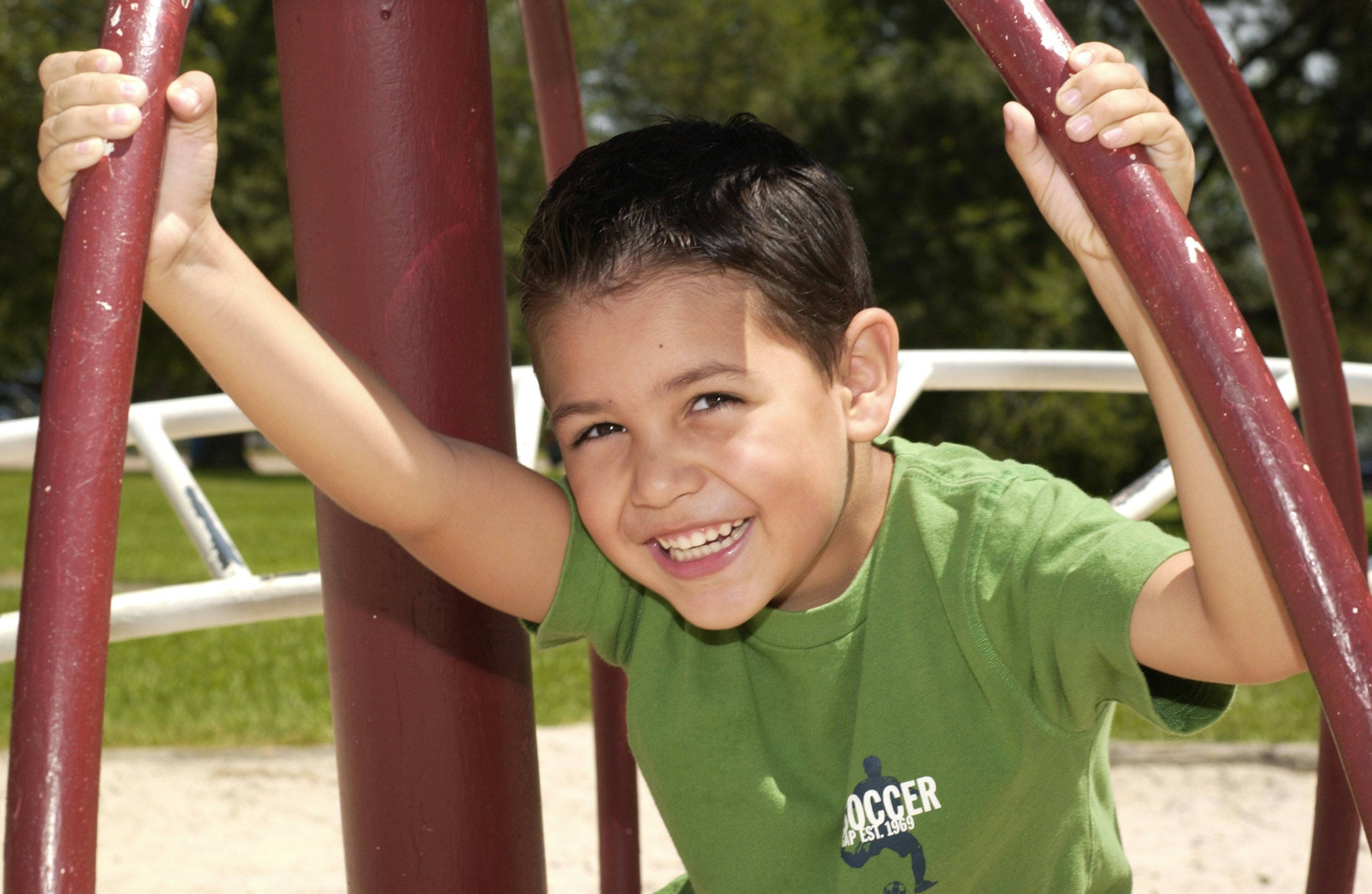 boy in green crew neck t-shirt smiling
