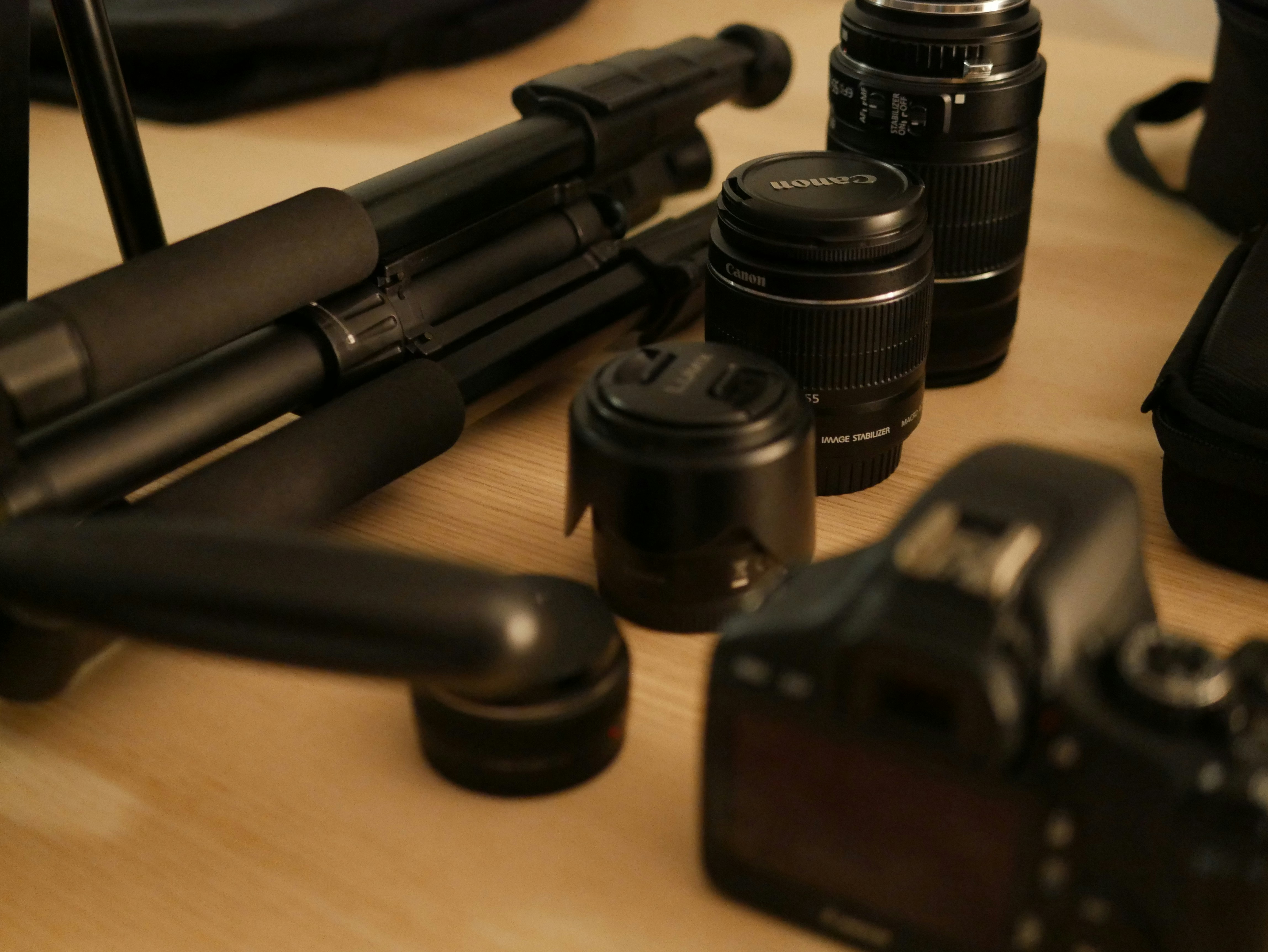 black camera lens on brown wooden table