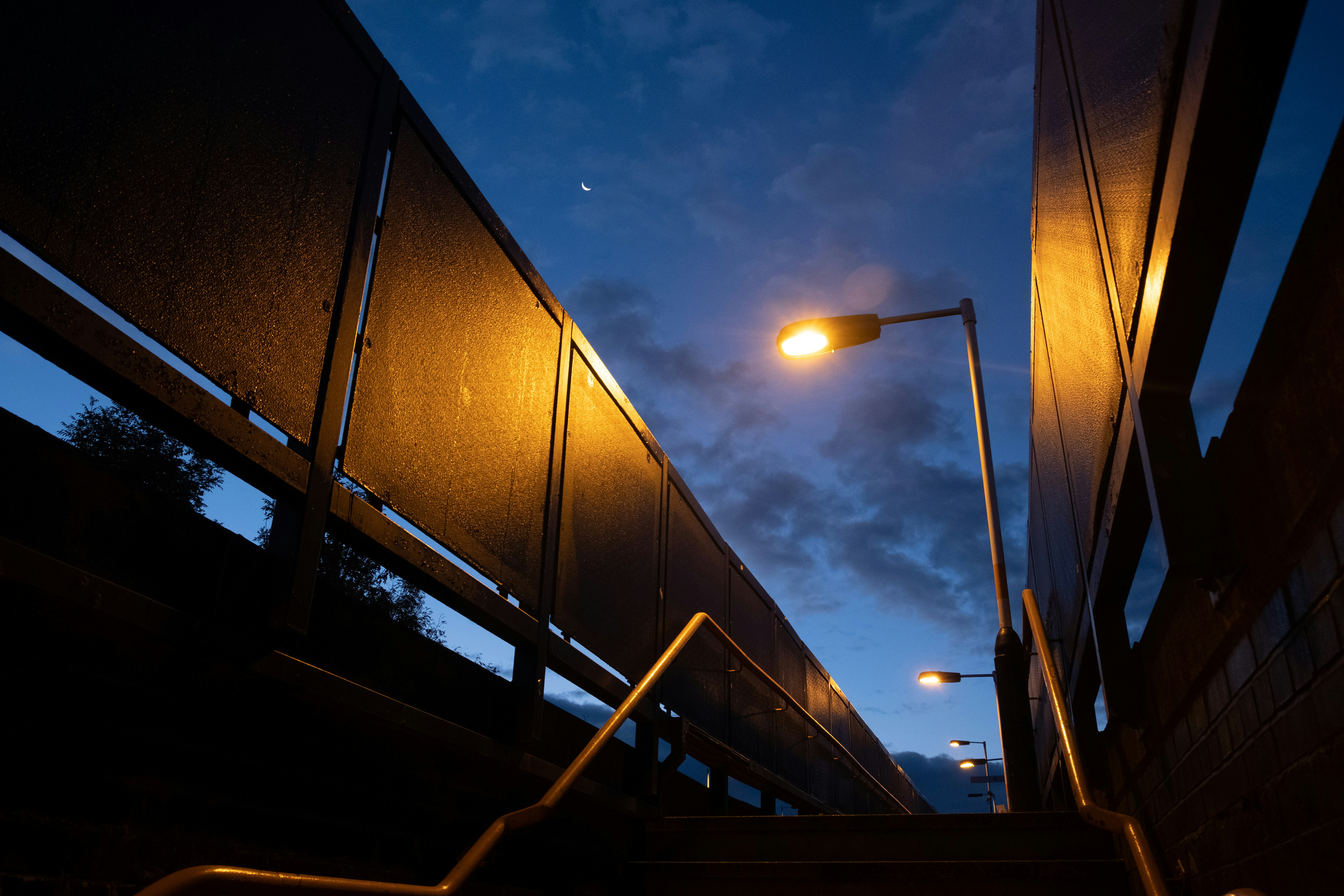 Moonlit Ascent: An Orange-Glow Urban Staircase Reaching Toward the Sky