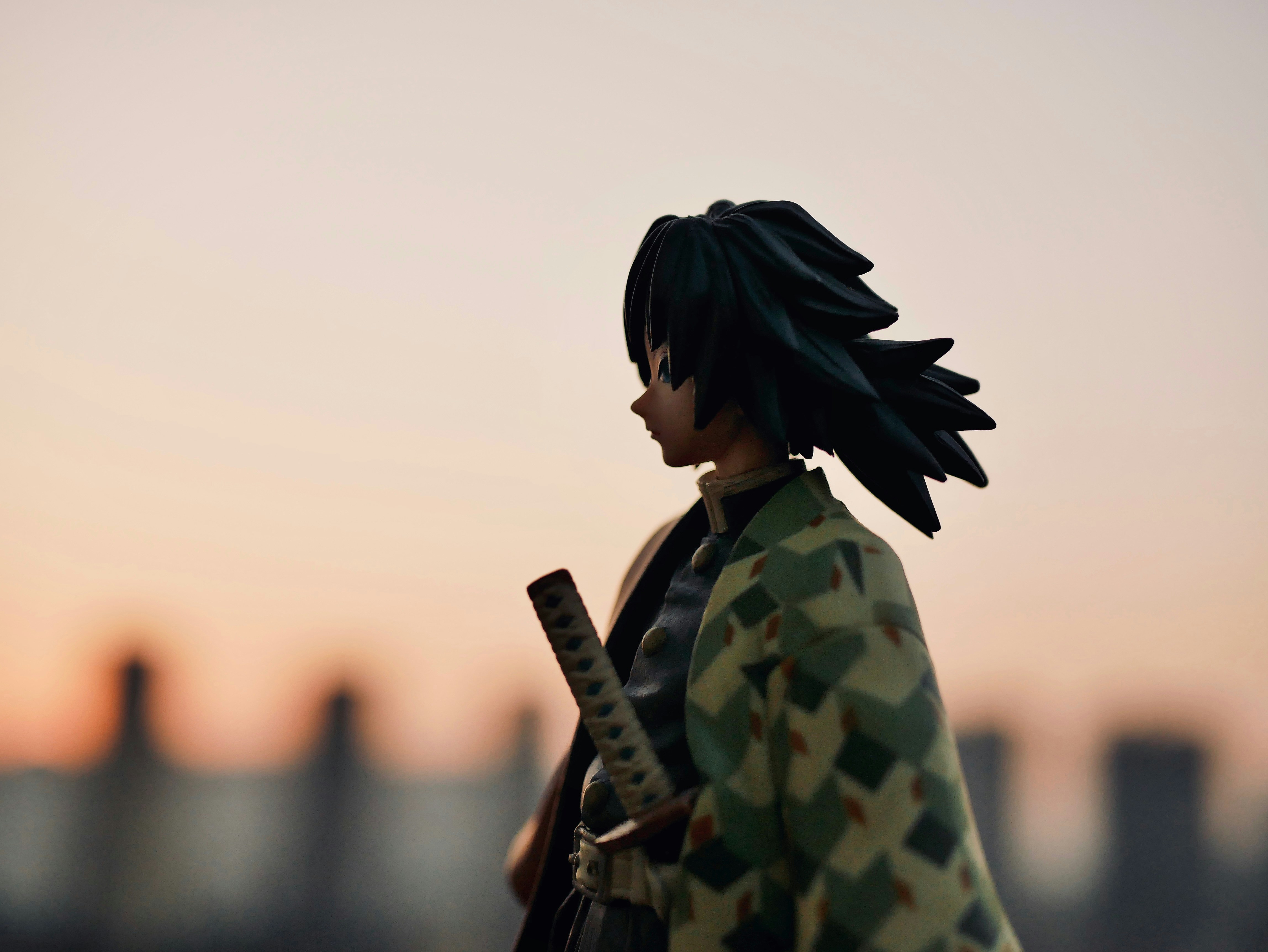 Moonlit Warrior: A Figurine Amid Sunset Silhouette