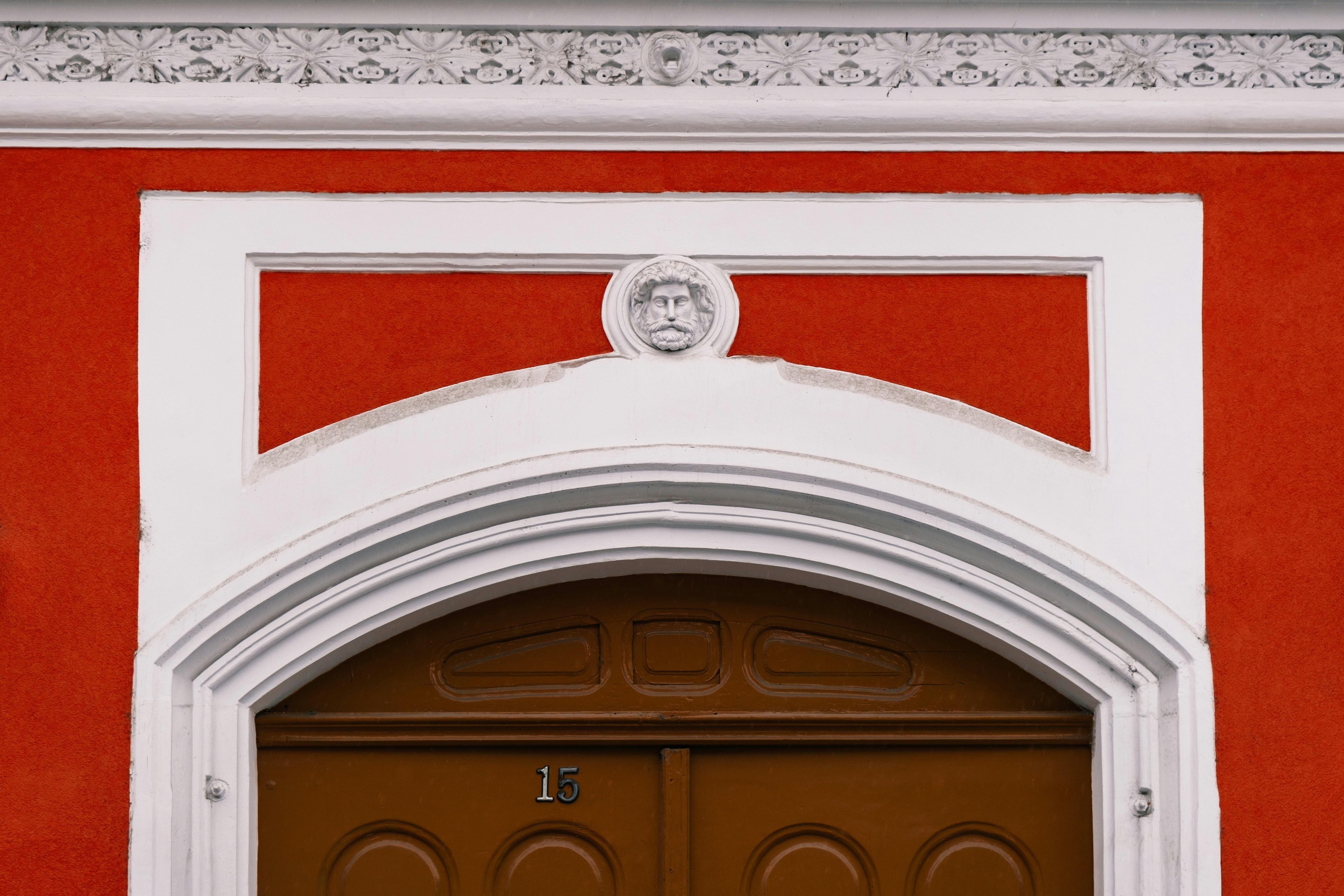 Arcaded White Frame Over Red Doorway