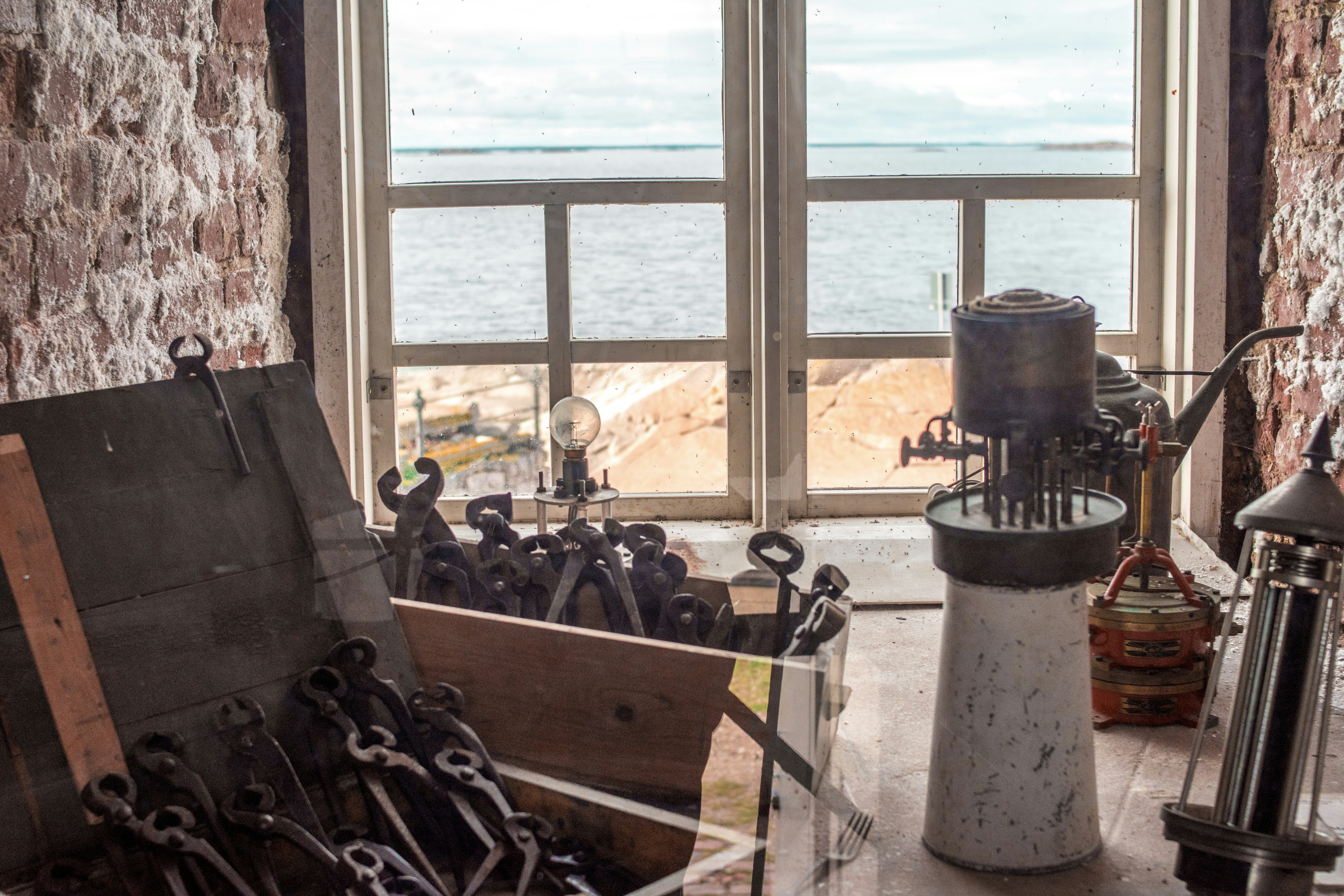 Sunlit Window Overlooks a Vintage Workshop of Tools and Copper Boiler