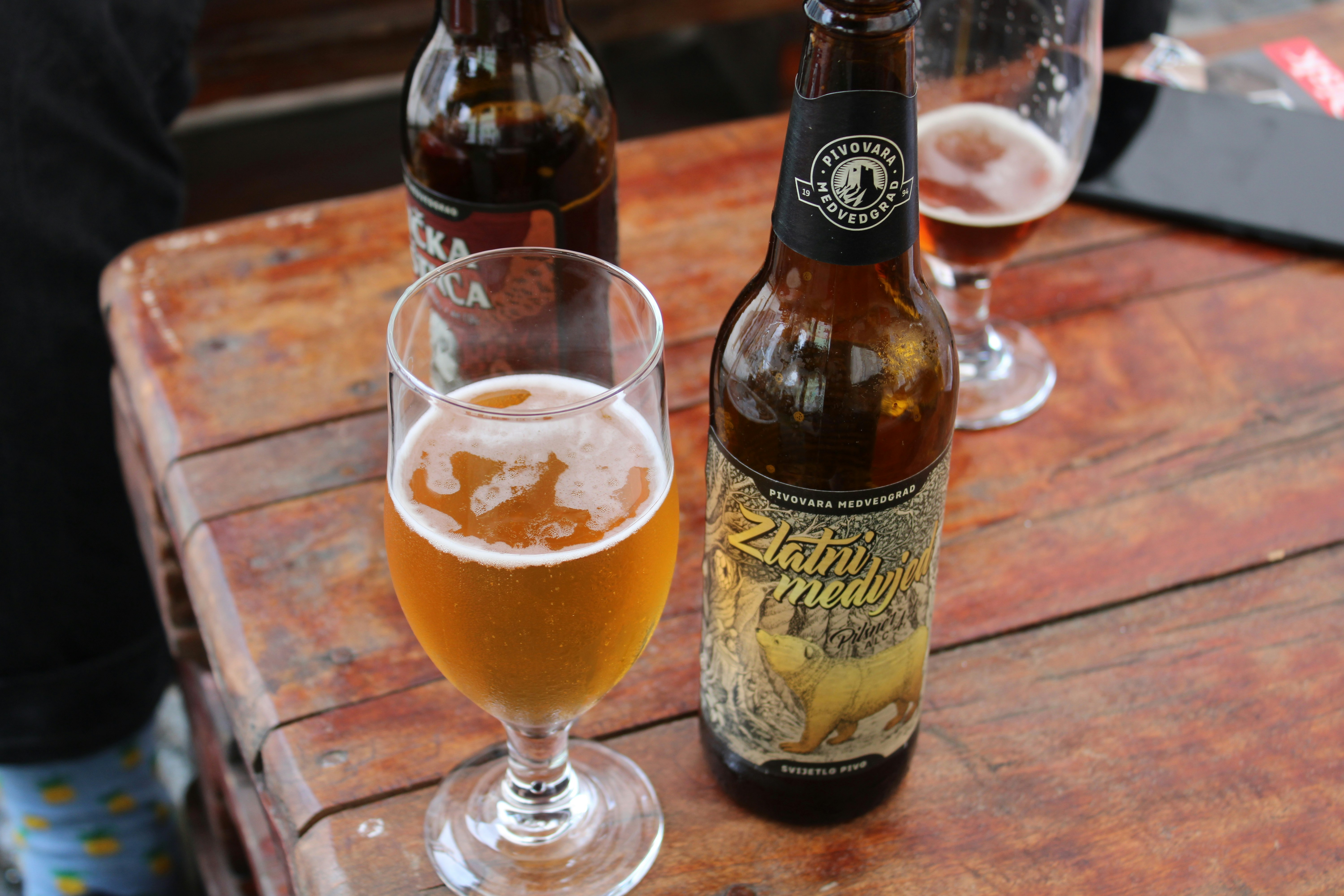 Amber Toast: Glass and Bottle on a Weathered Wood Table