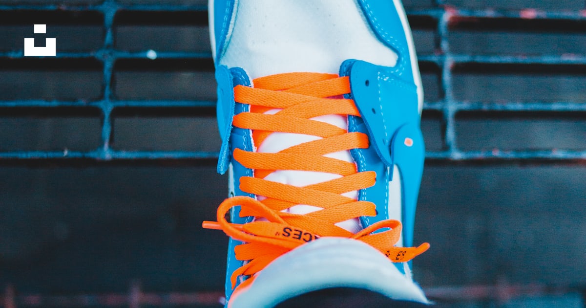 Person Wearing Blue And White Nike Athletic Shoe Photo Free Apparel