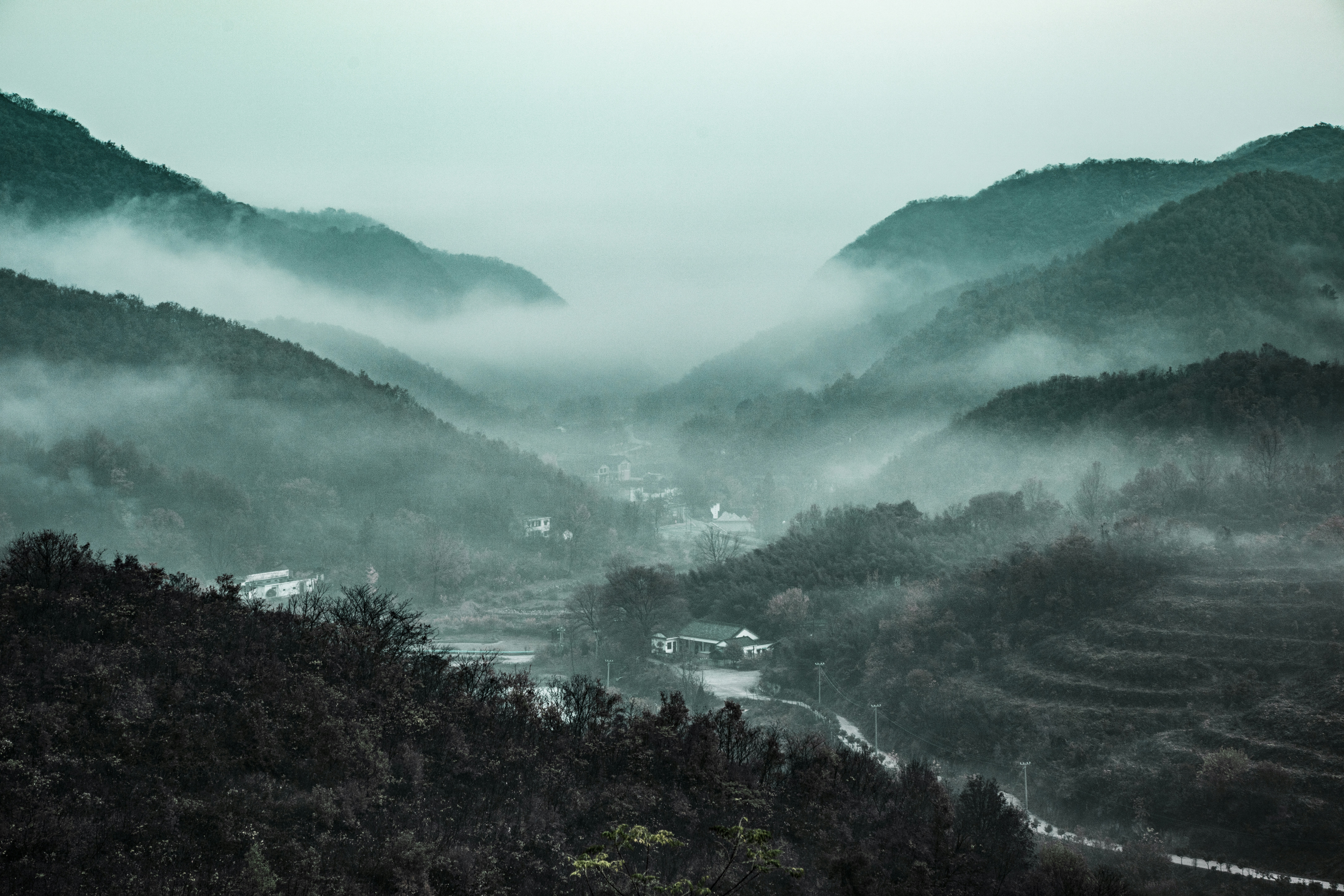 Mist-veiled Valley over Terraced Hills