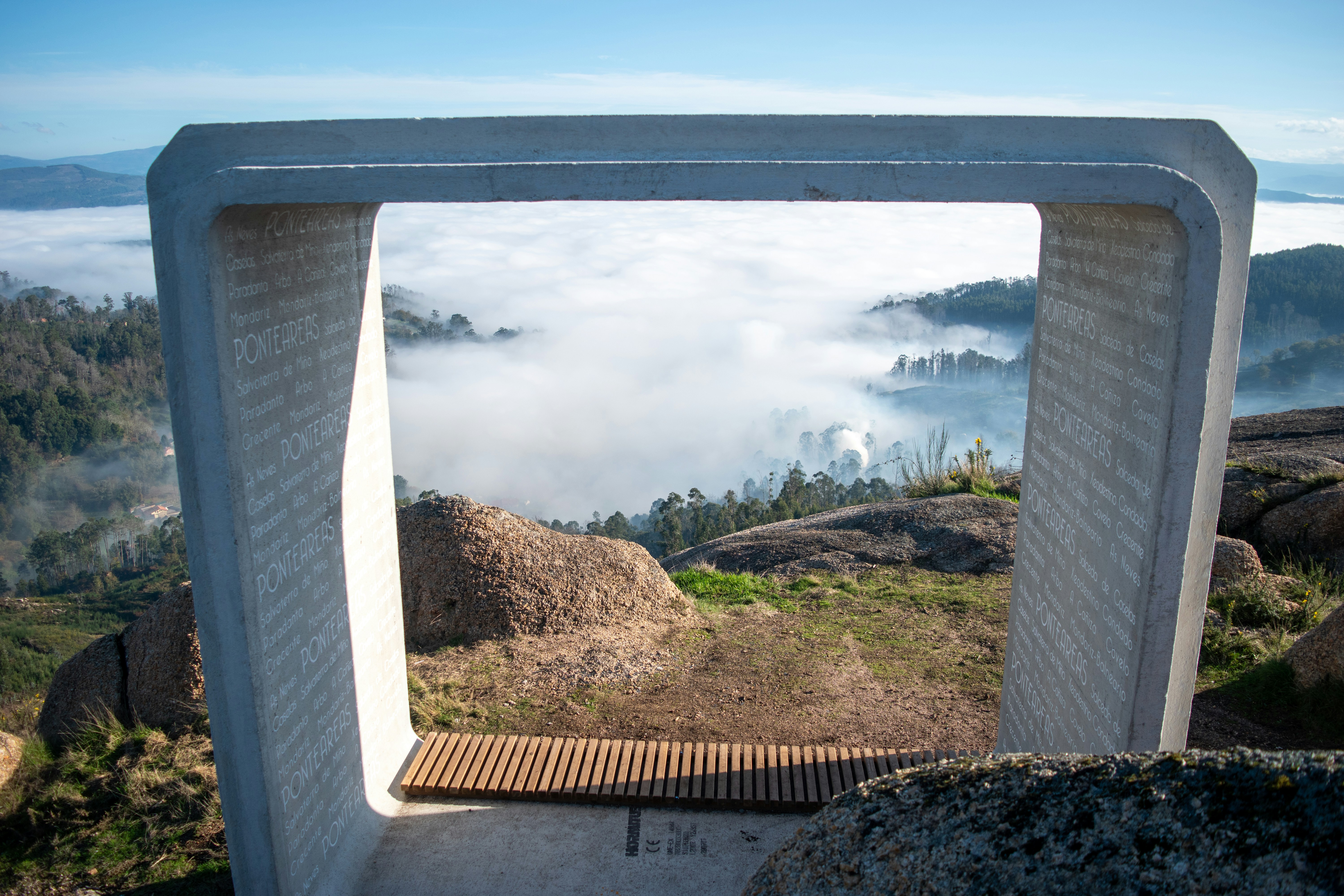 Gateway to the Mist: Concrete Frame Framing a Sea of Fog Over the Ridge