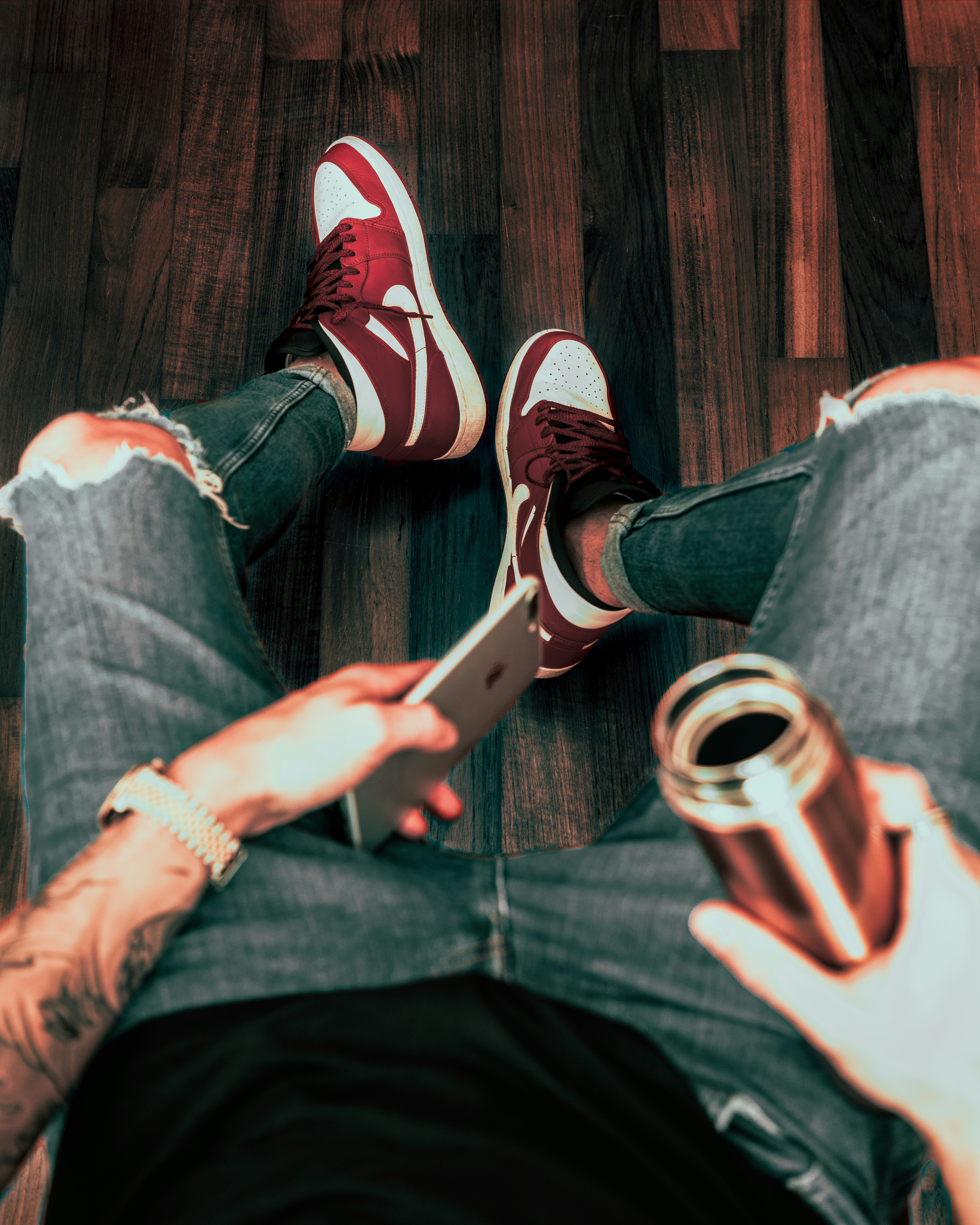 Overhead Moment: Burgundy Sneakers and a Quiet Phone Pause