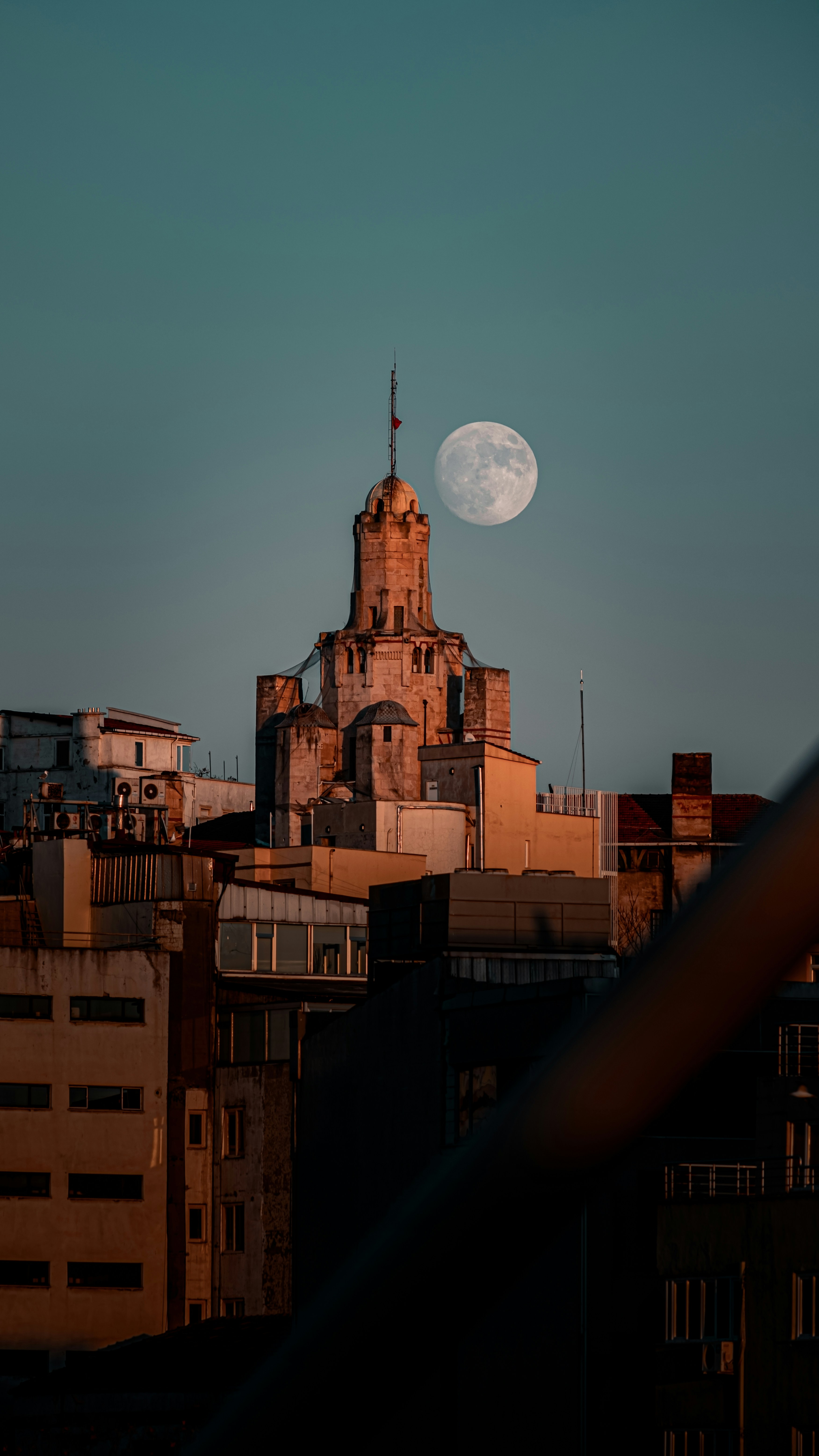 Moonlit Silhouette Over Urban Spire