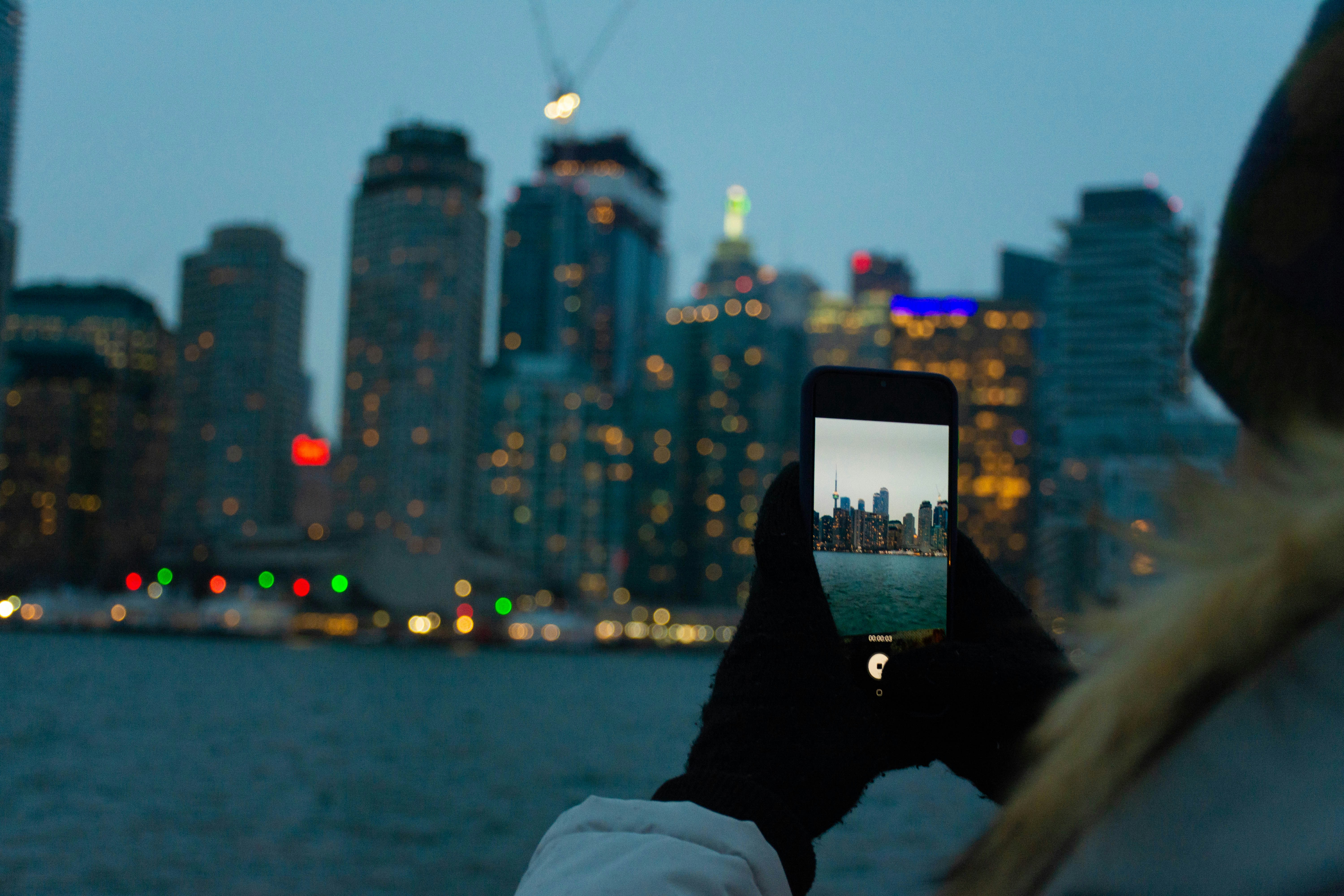 Frame Within a Frame: Night Skyline Through a Phone Screen
