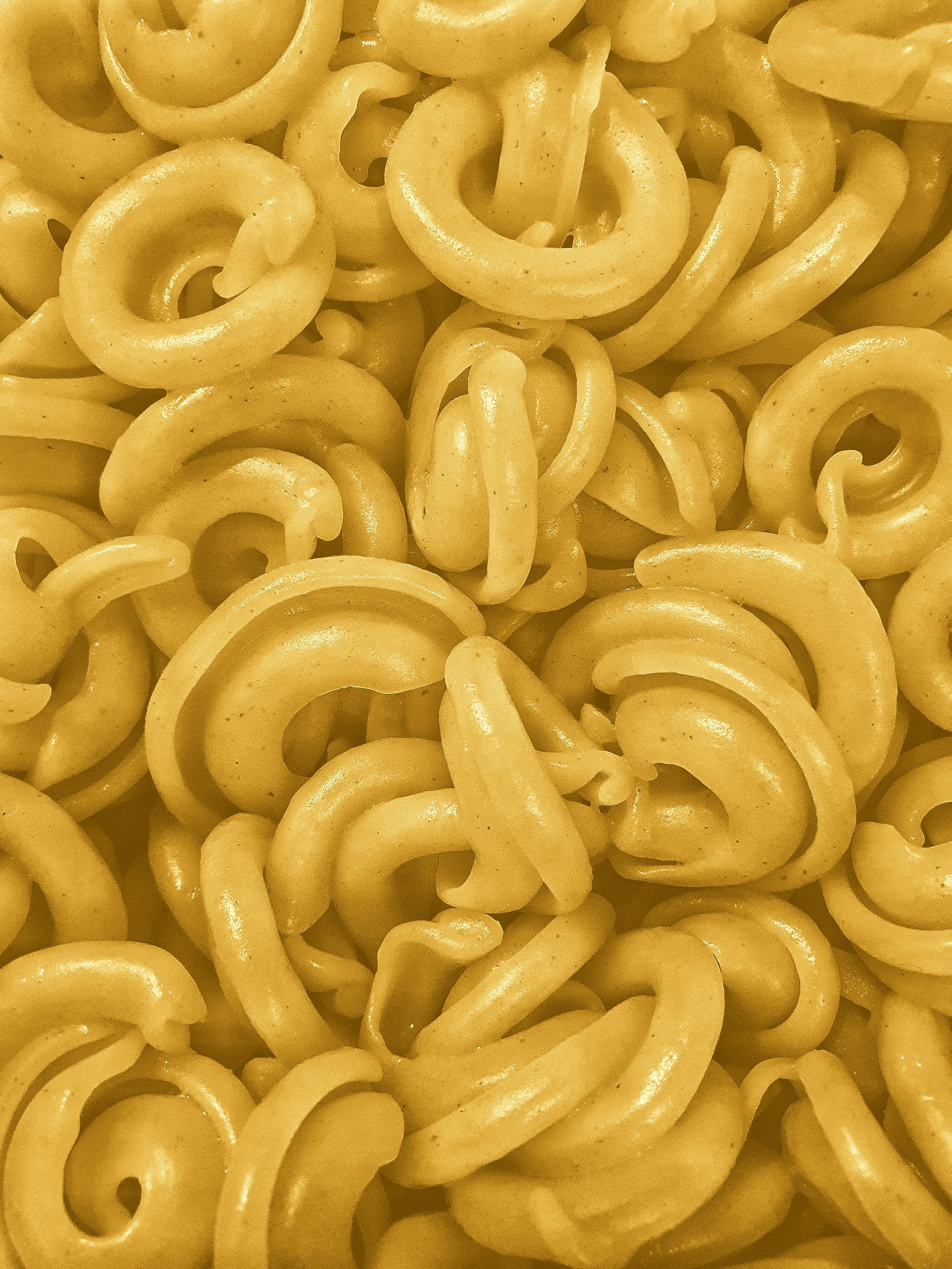 Close-up of spiraled pasta pieces arranged densely, showcasing their unique shapes and textures.