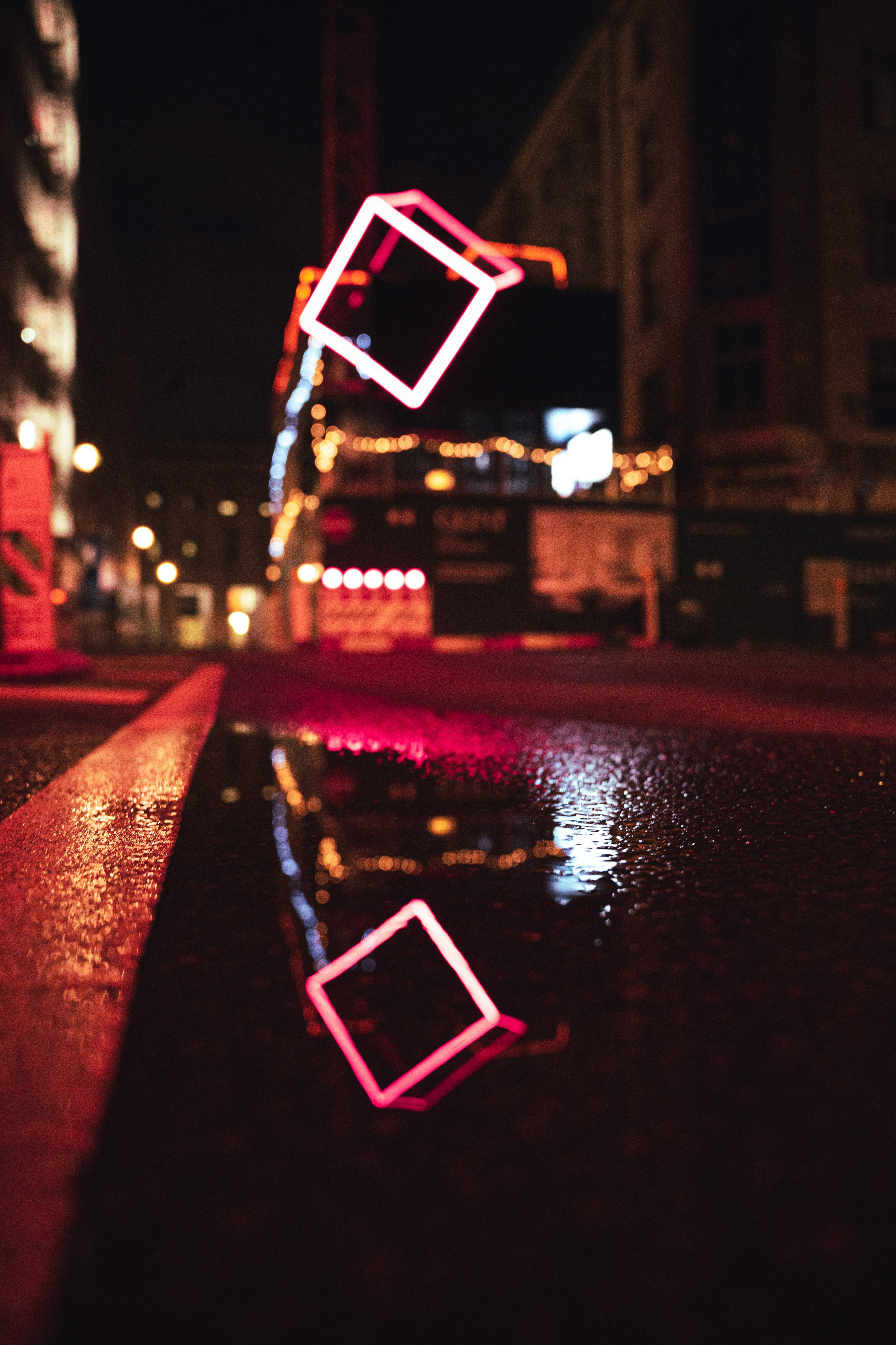 Neon Cube Reflections on Rainy Street Night