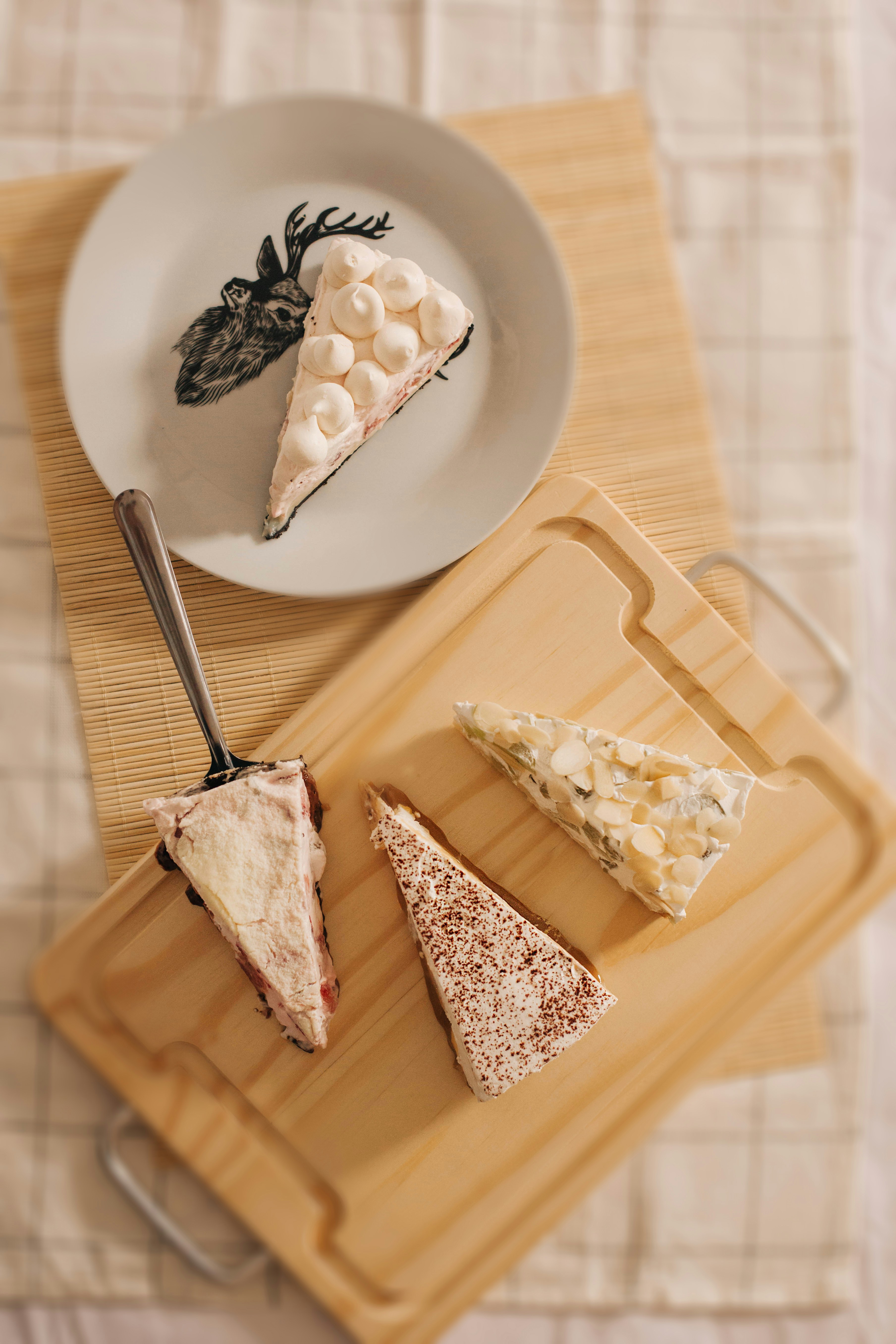 Cream-Topped Cakes on a Rustic Board, Framed by a Deer-Illustrated Plate