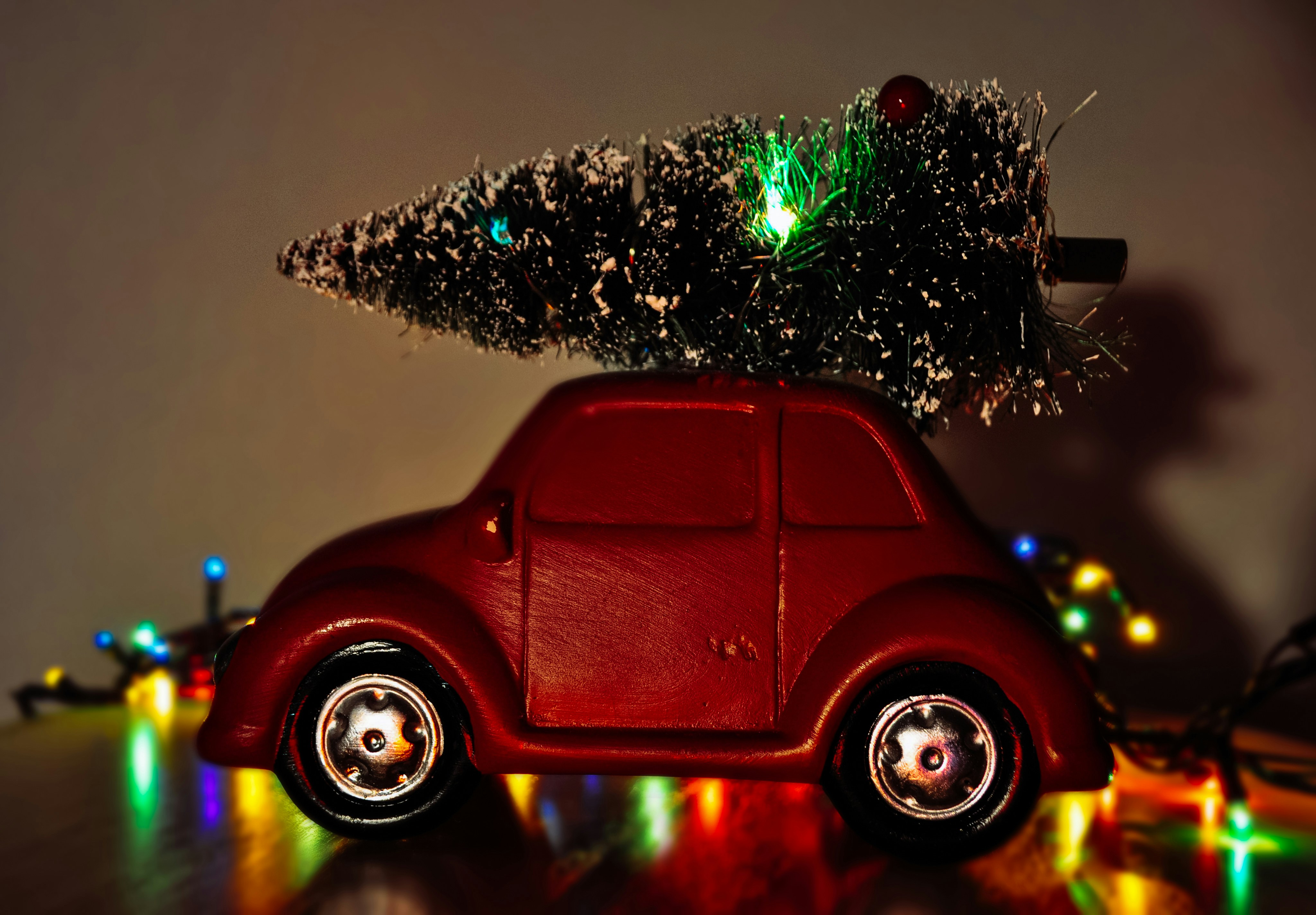 Tiny red car, tiny tree: a cheerful holiday still-life
