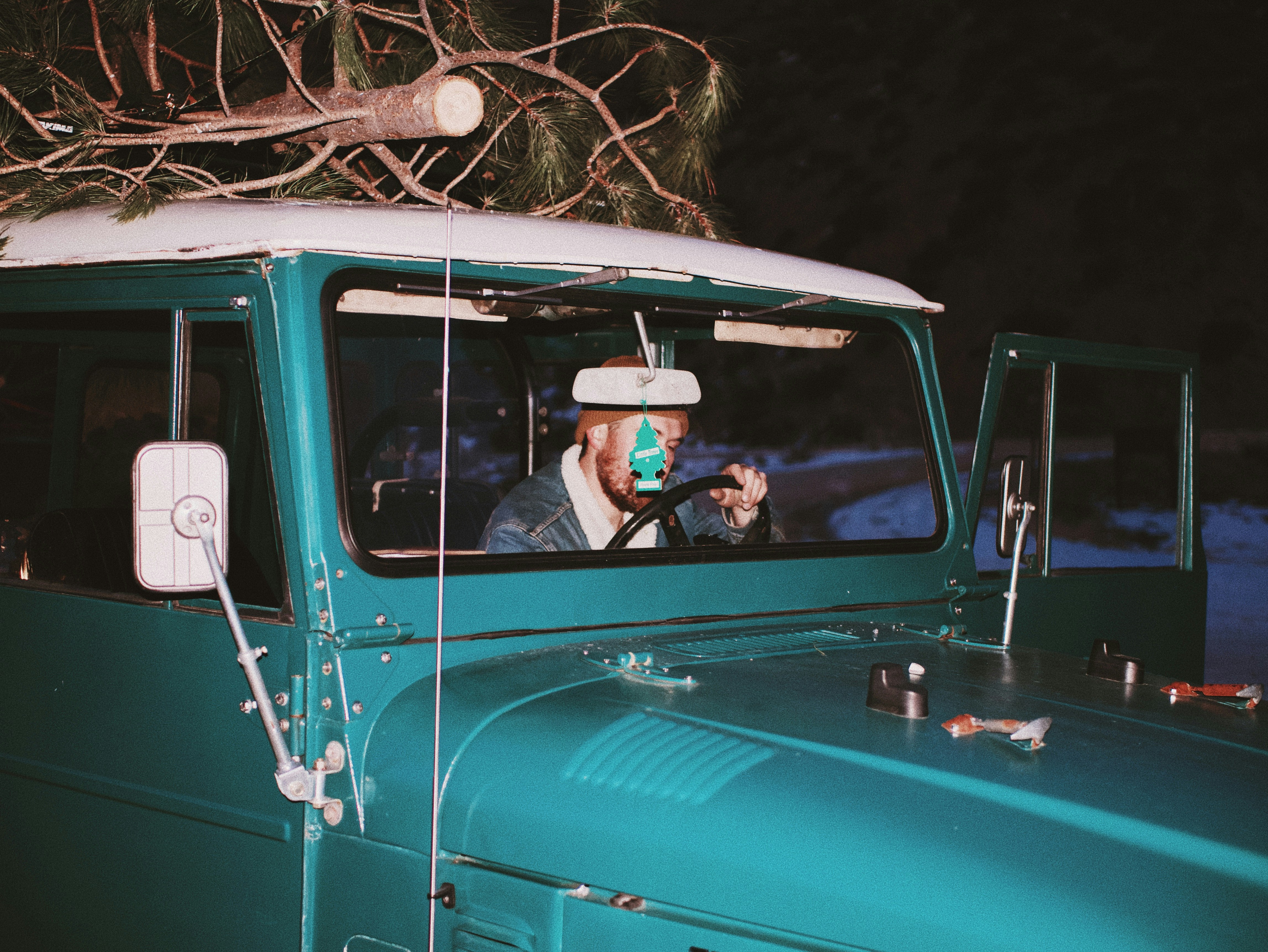 man in blue crew cab pickup truck