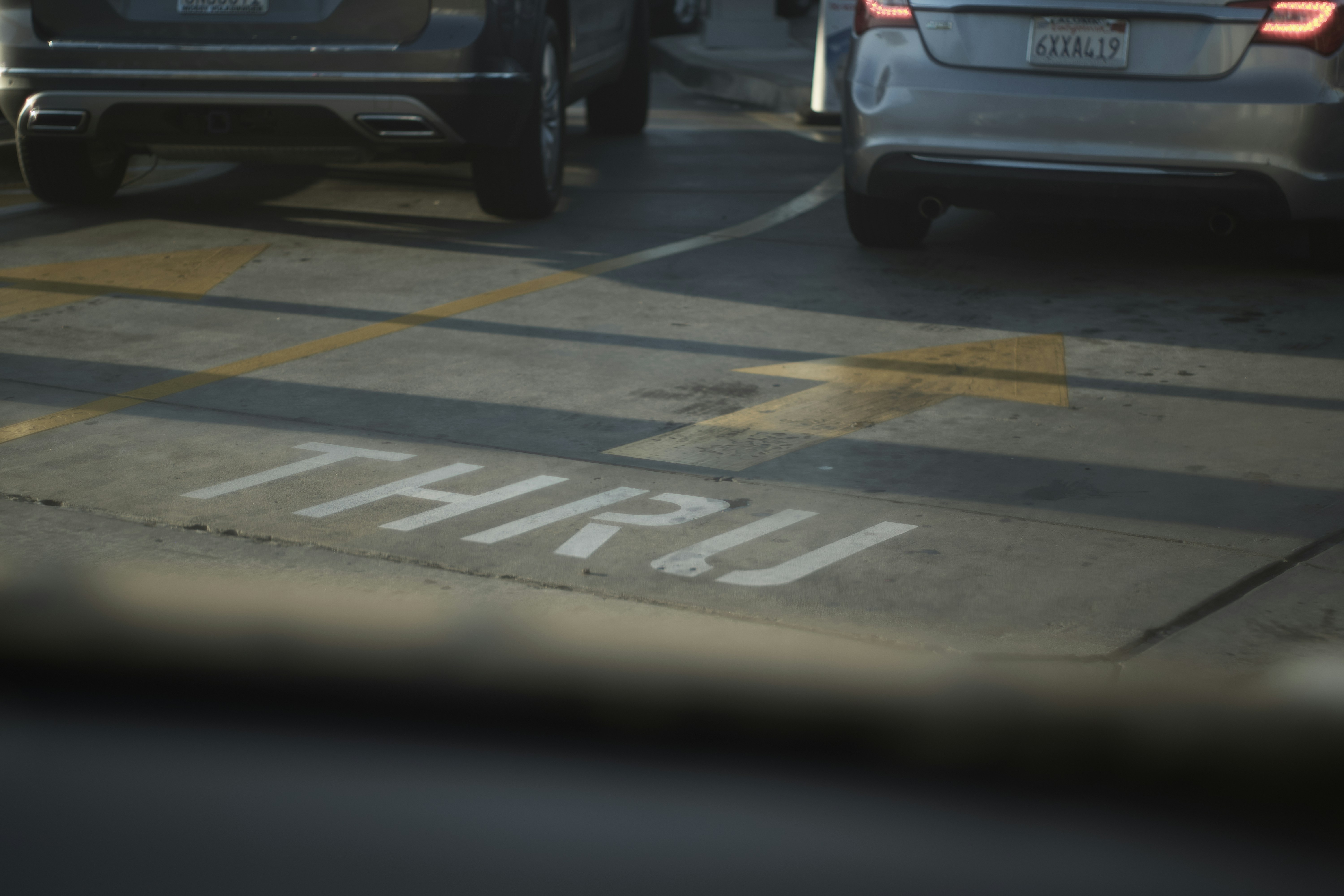 Thru the Lines: A Quiet Ground-Level Parking Lot Portrait