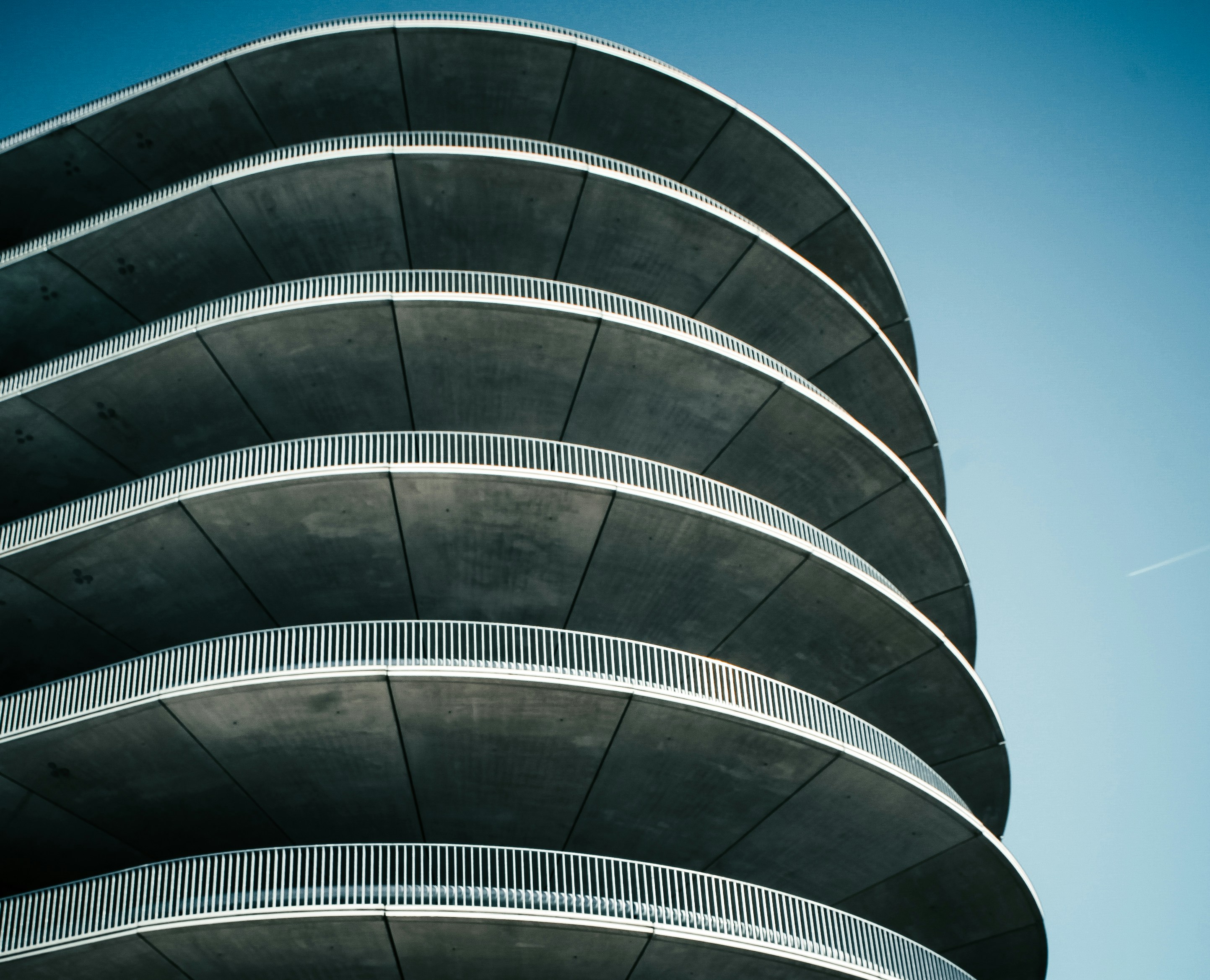 Spiral Levels: A Concrete Parking Garage Ascends Against the Sky