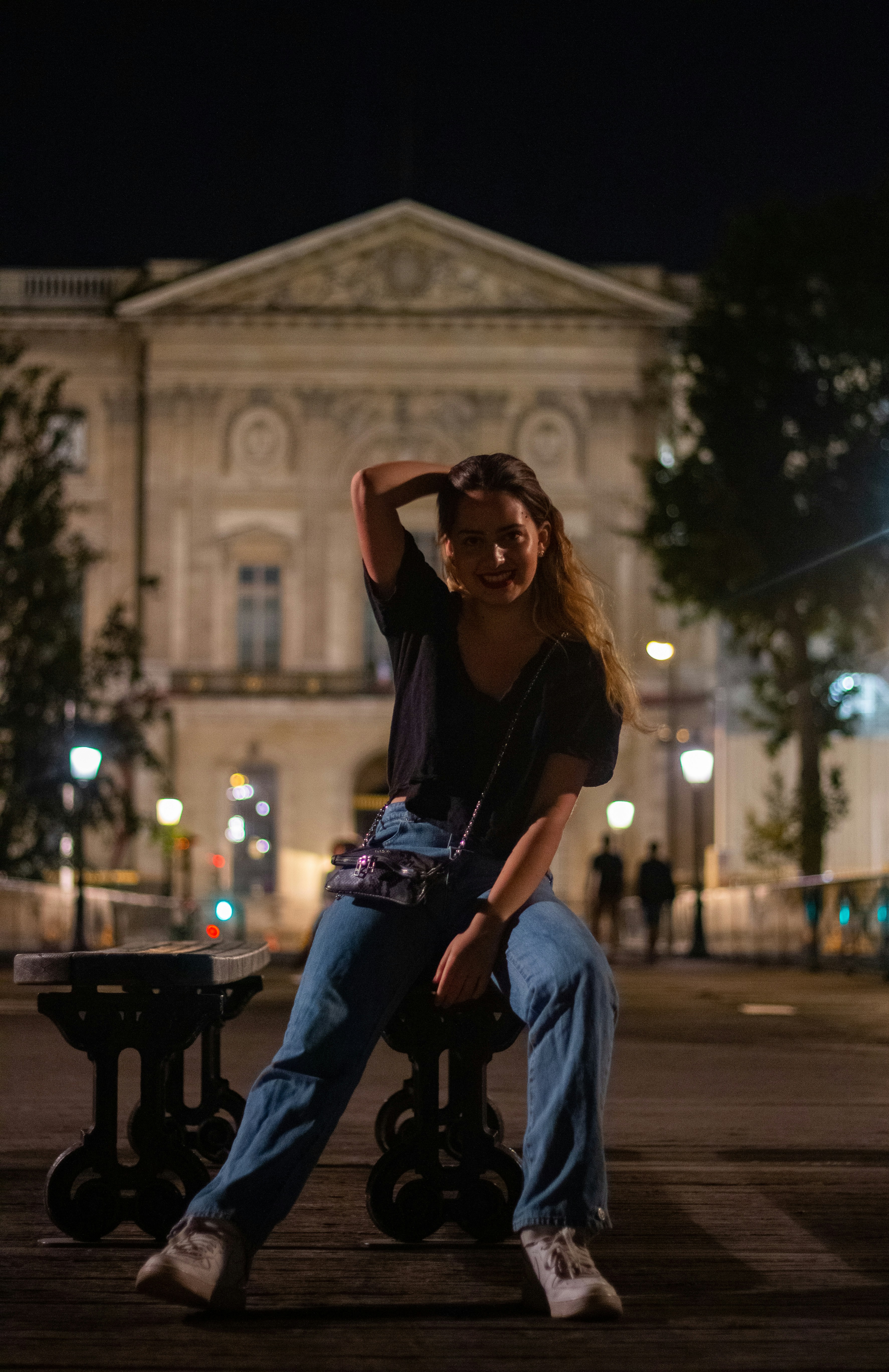 Night Portrait on the Plaza: A Casual Moment Before the Historic Facade