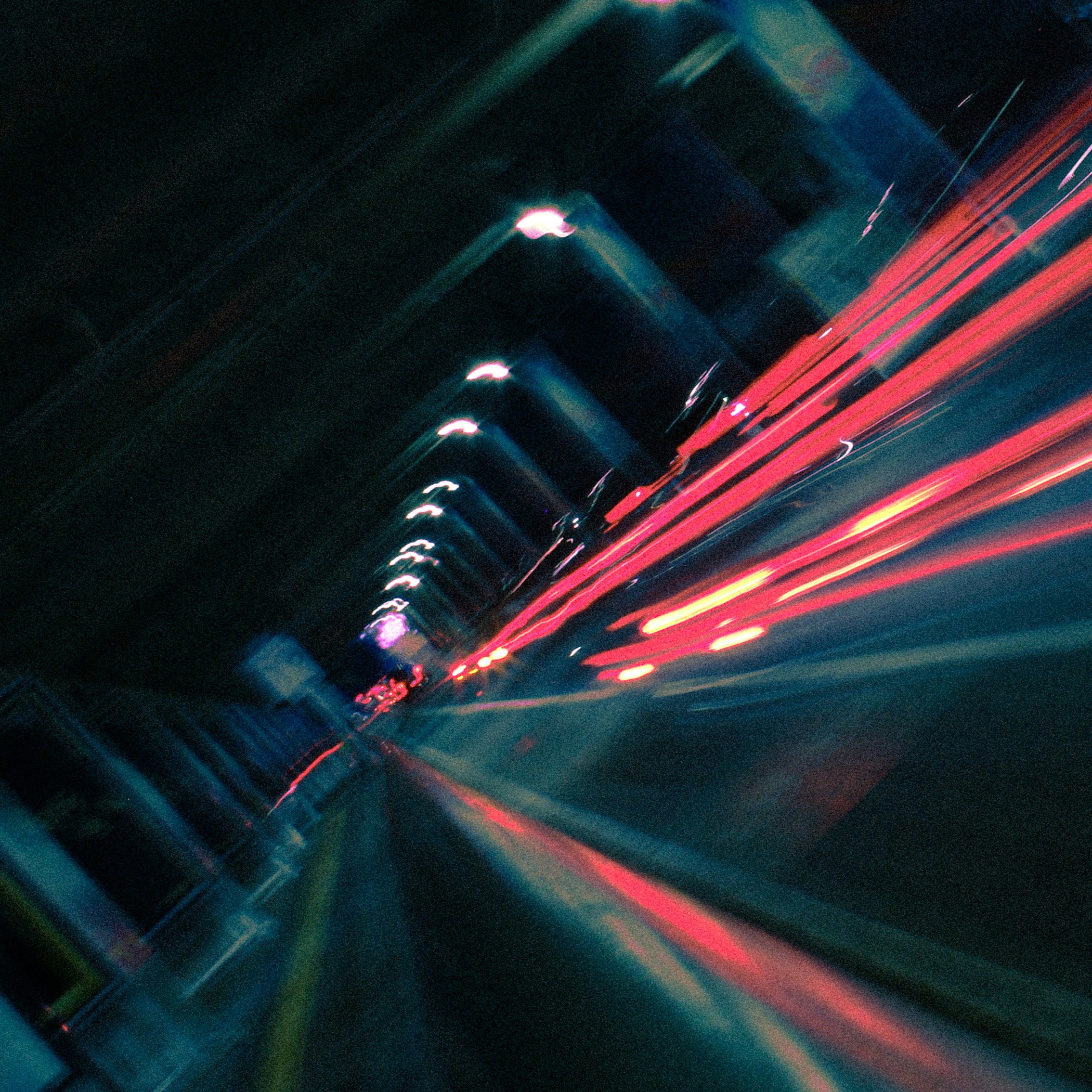 Neon Veins in a Midnight Tunnel: Red Light Trails in Motion