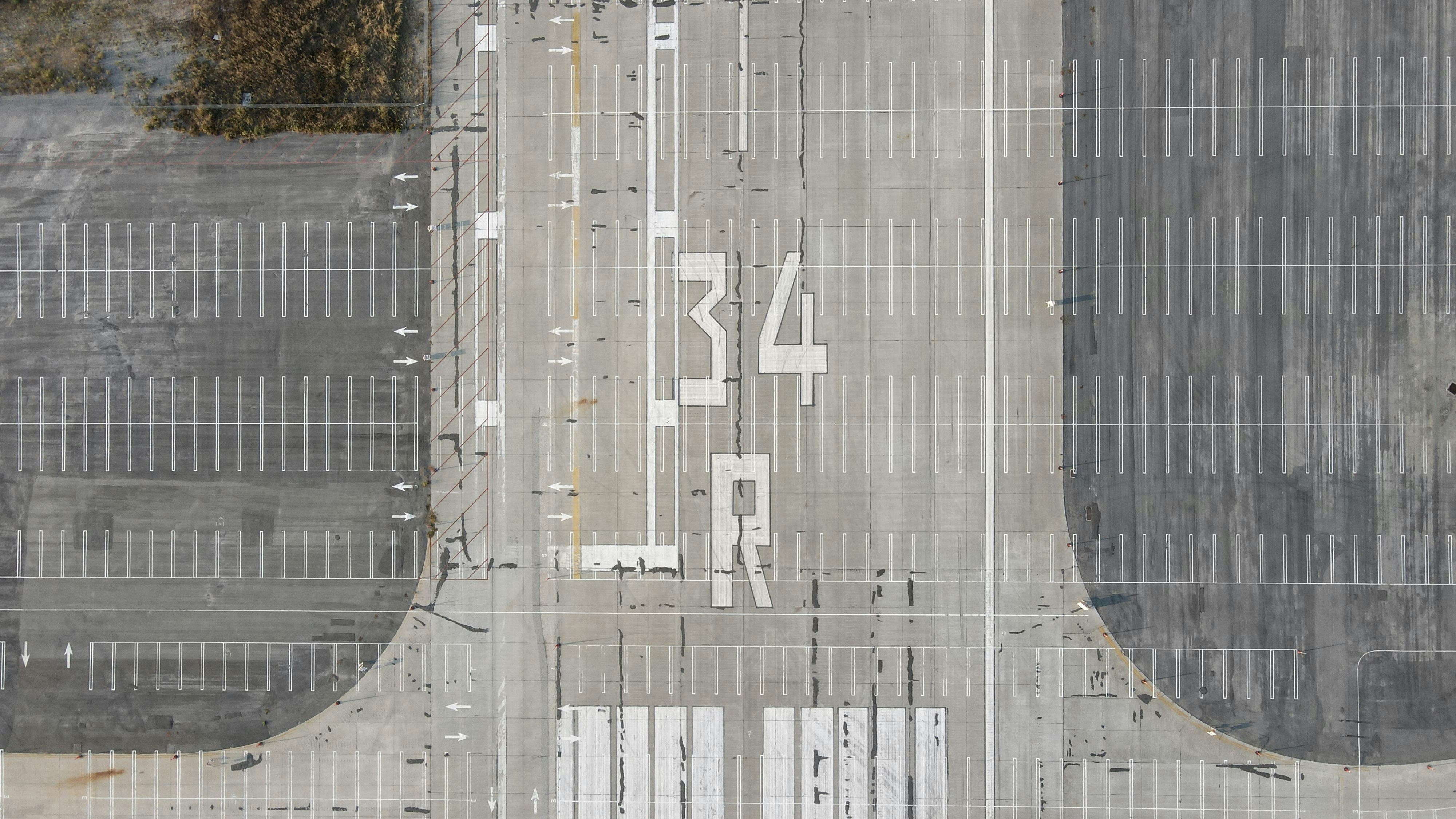 This is the last remaining piece of the El Toro MCAS in Lake Forest, California. A parking lot was pointed over the runway. | white and gray concrete building