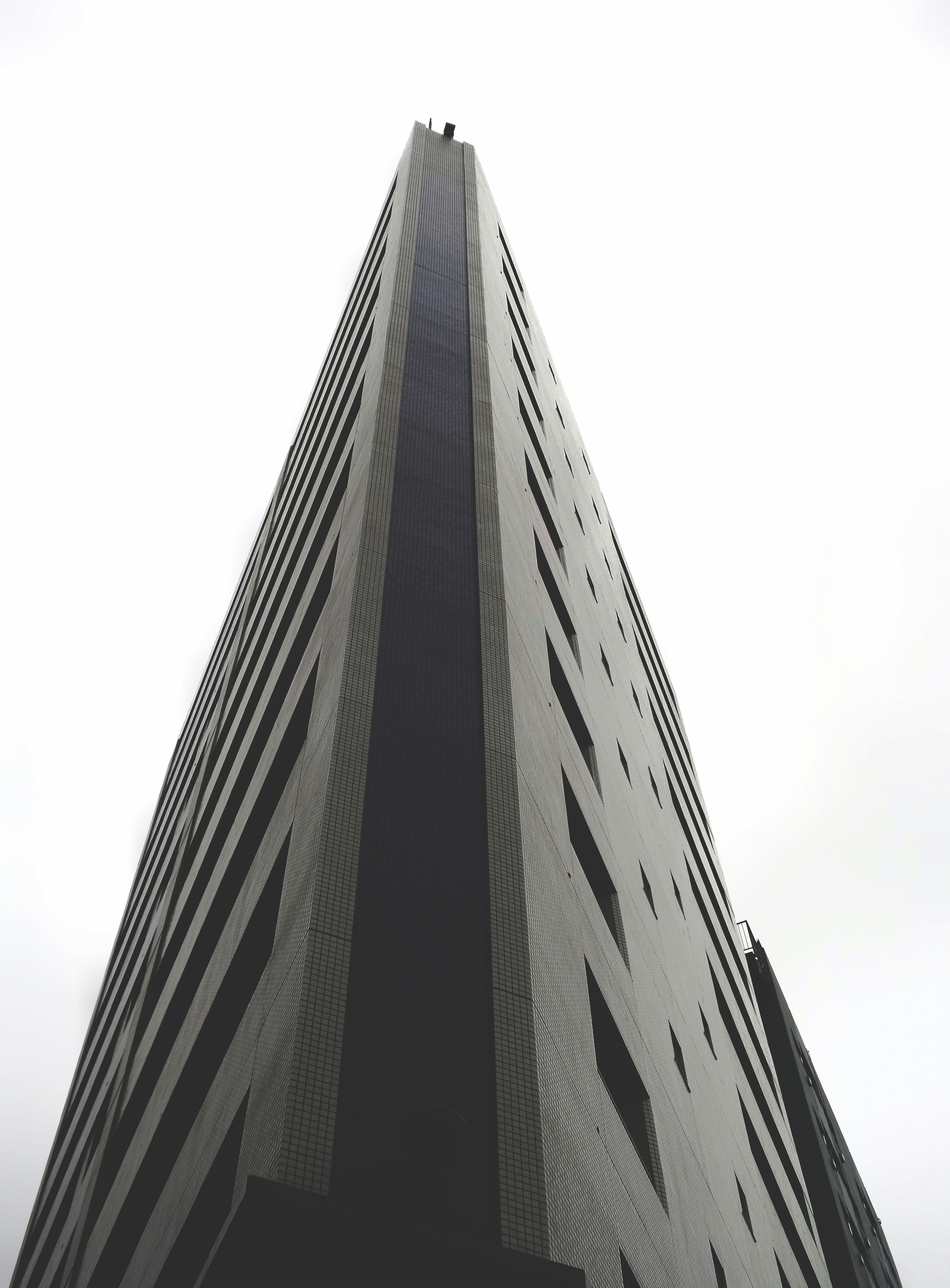A sleek, modern building stretching skyward, captured from a low angle to emphasize its height and architectural lines.