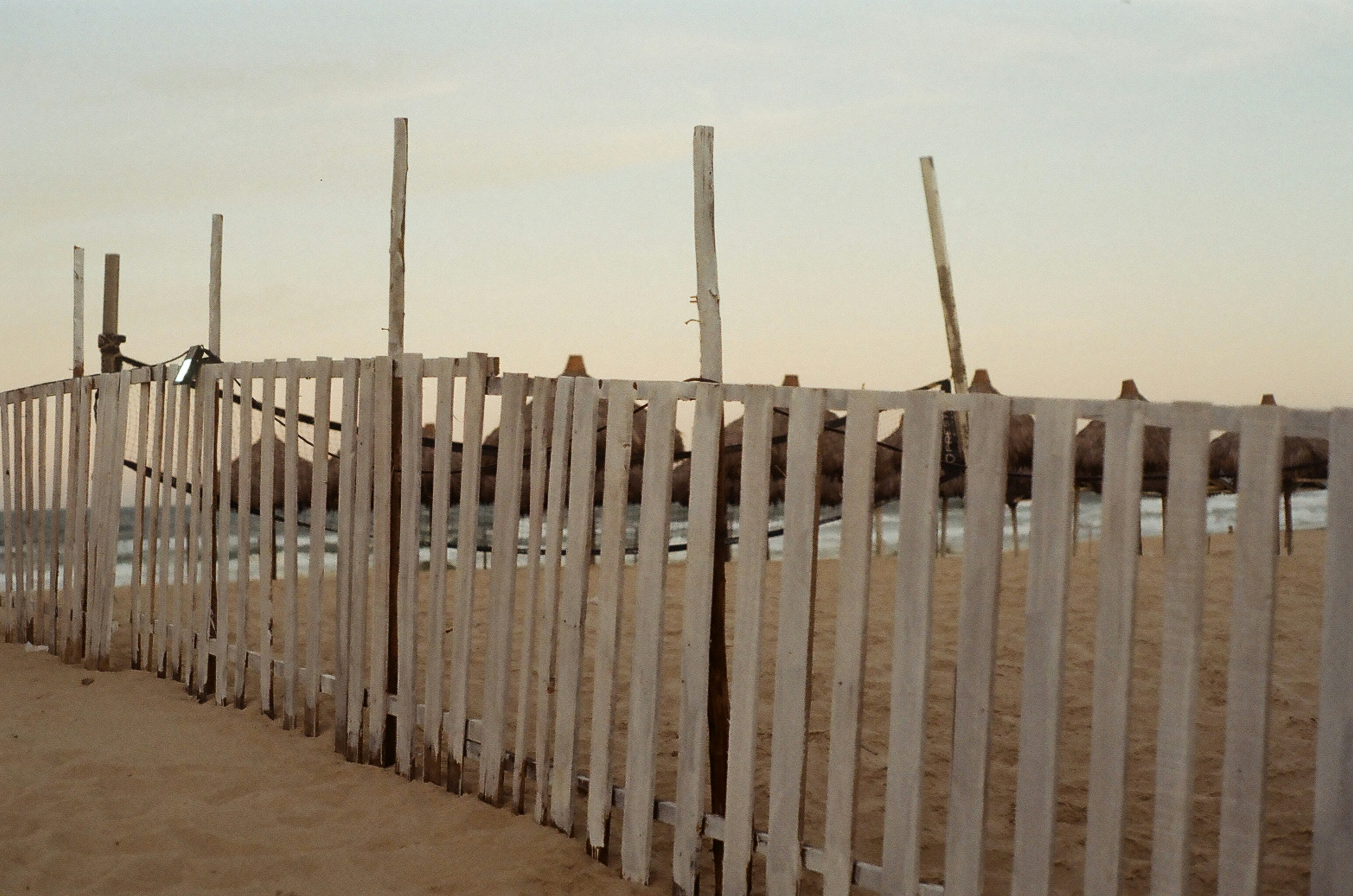 Brown wooden fence on brown sand during daytime photo – Free Grey Image ...