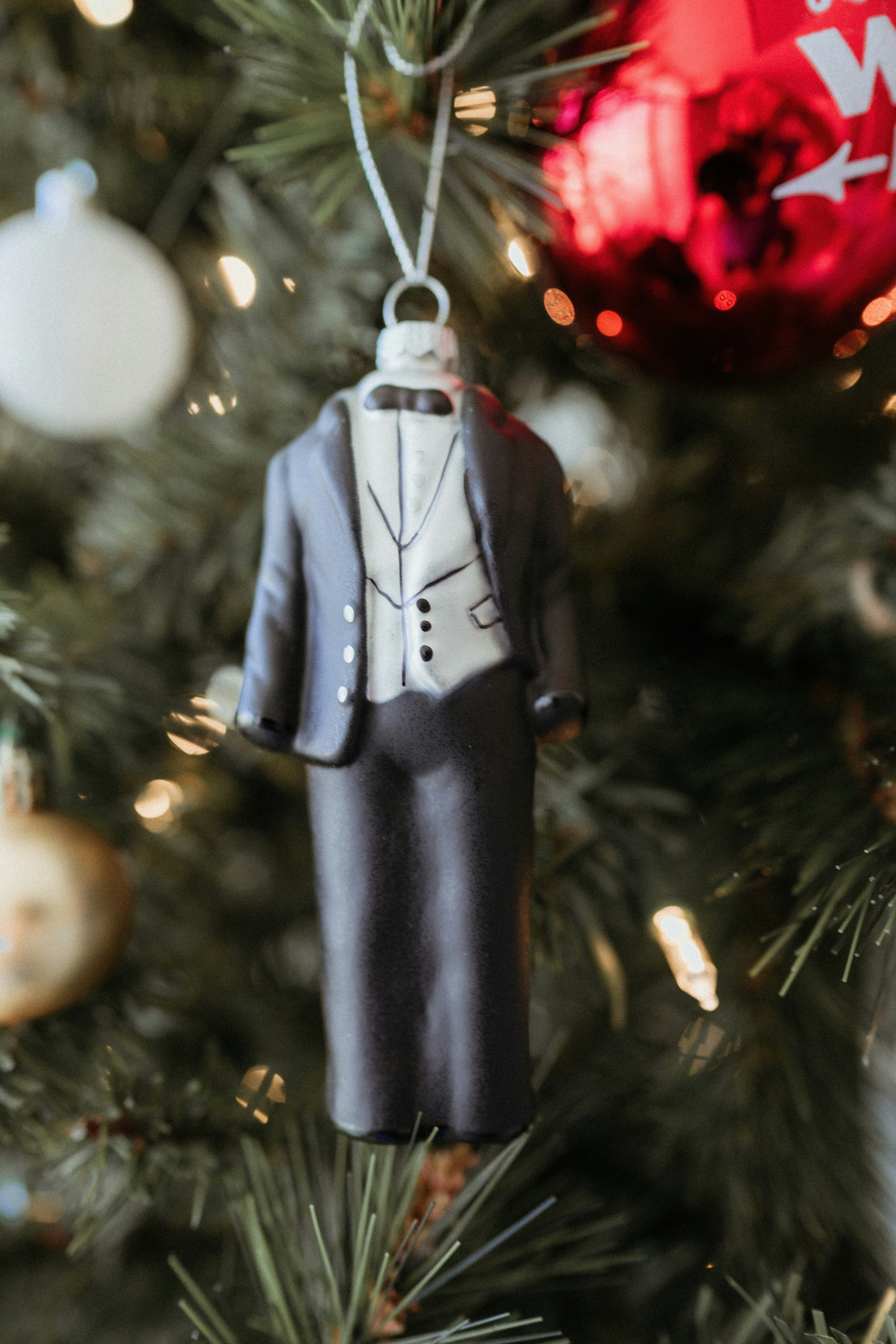 Miniature Gentleman Ornament Amid Soft Holiday Glow