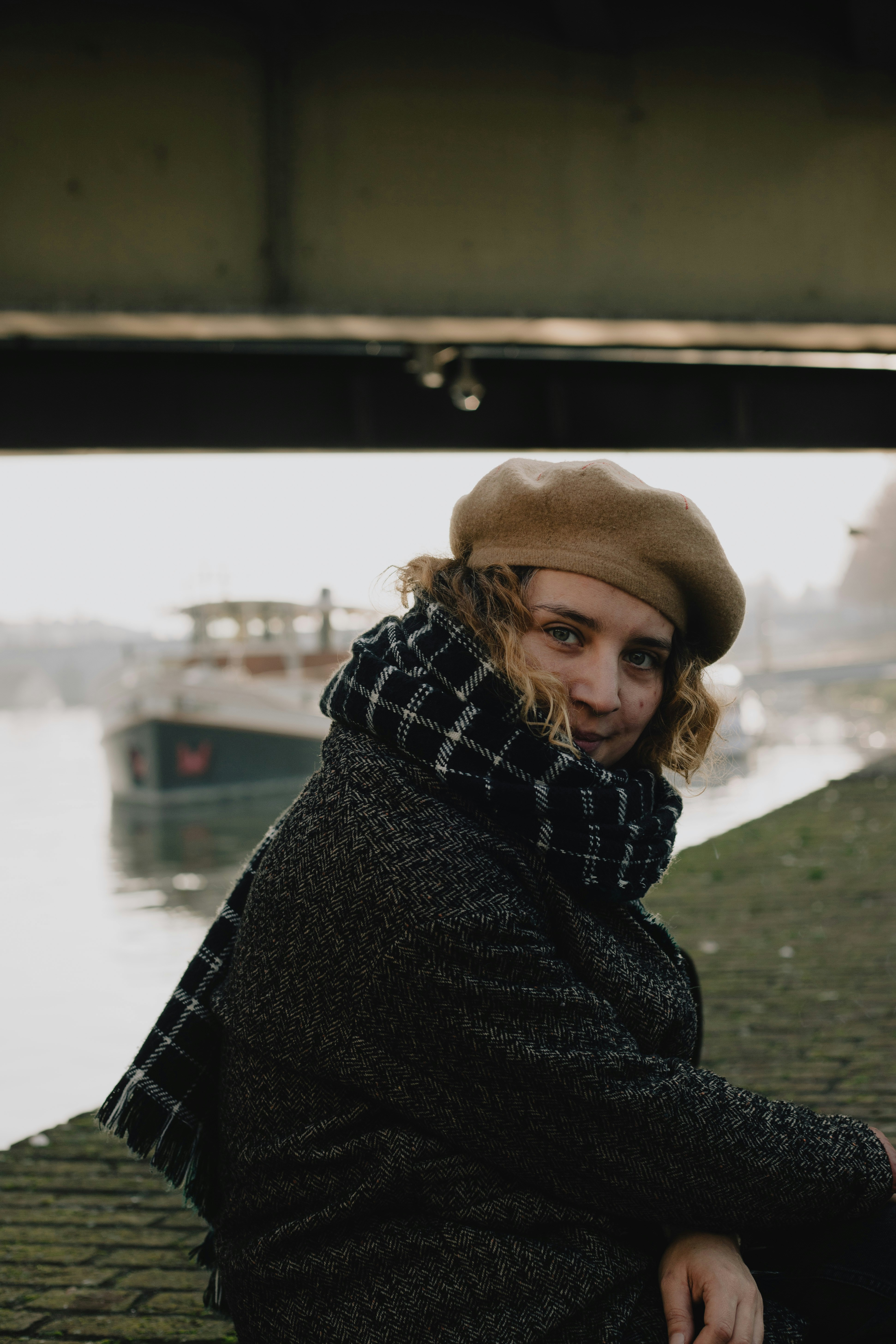 Beret by the Water: a Quiet Canal Portrait Beneath the Bridge