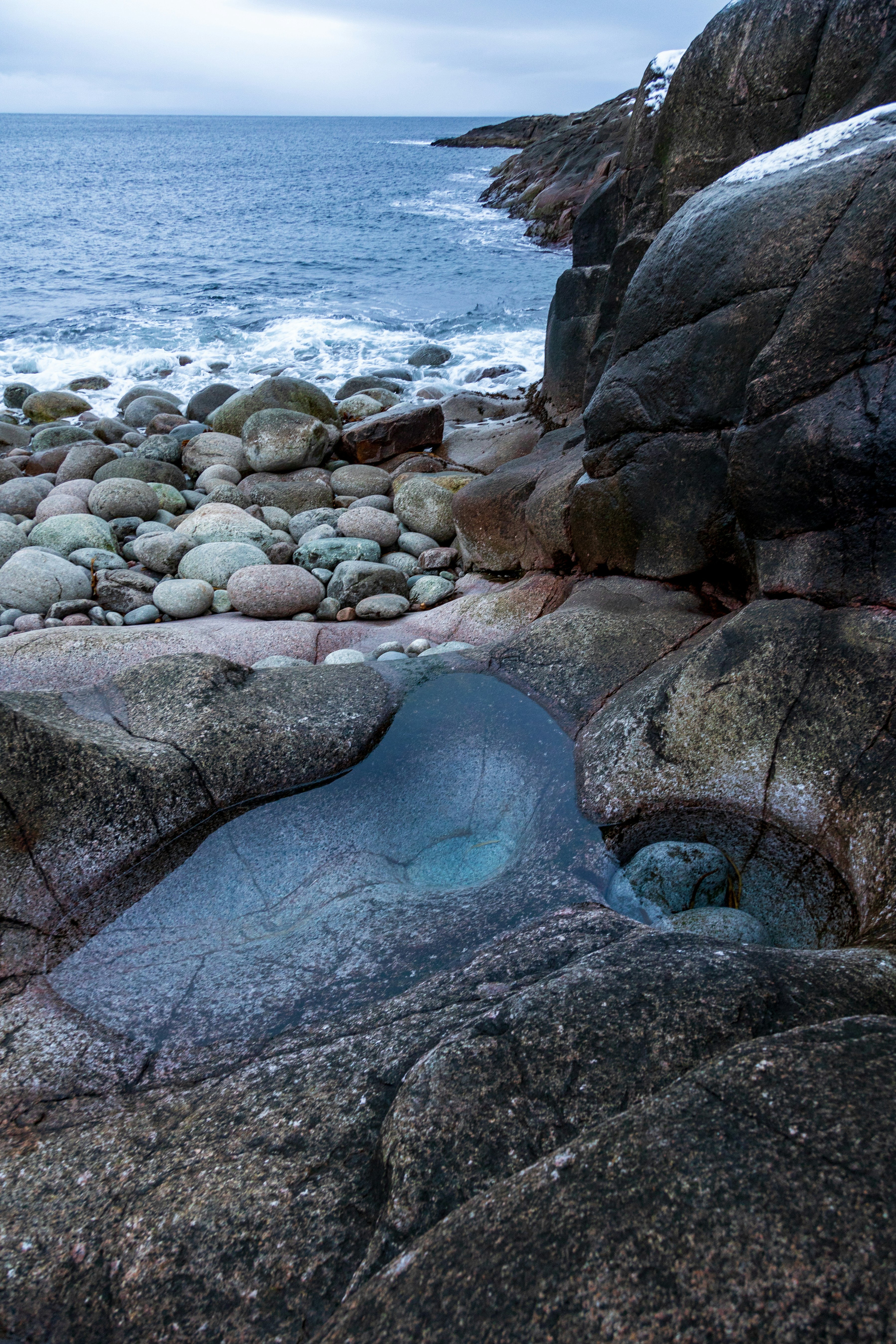 Blue Tide Pool Cradled by Weathered Granite