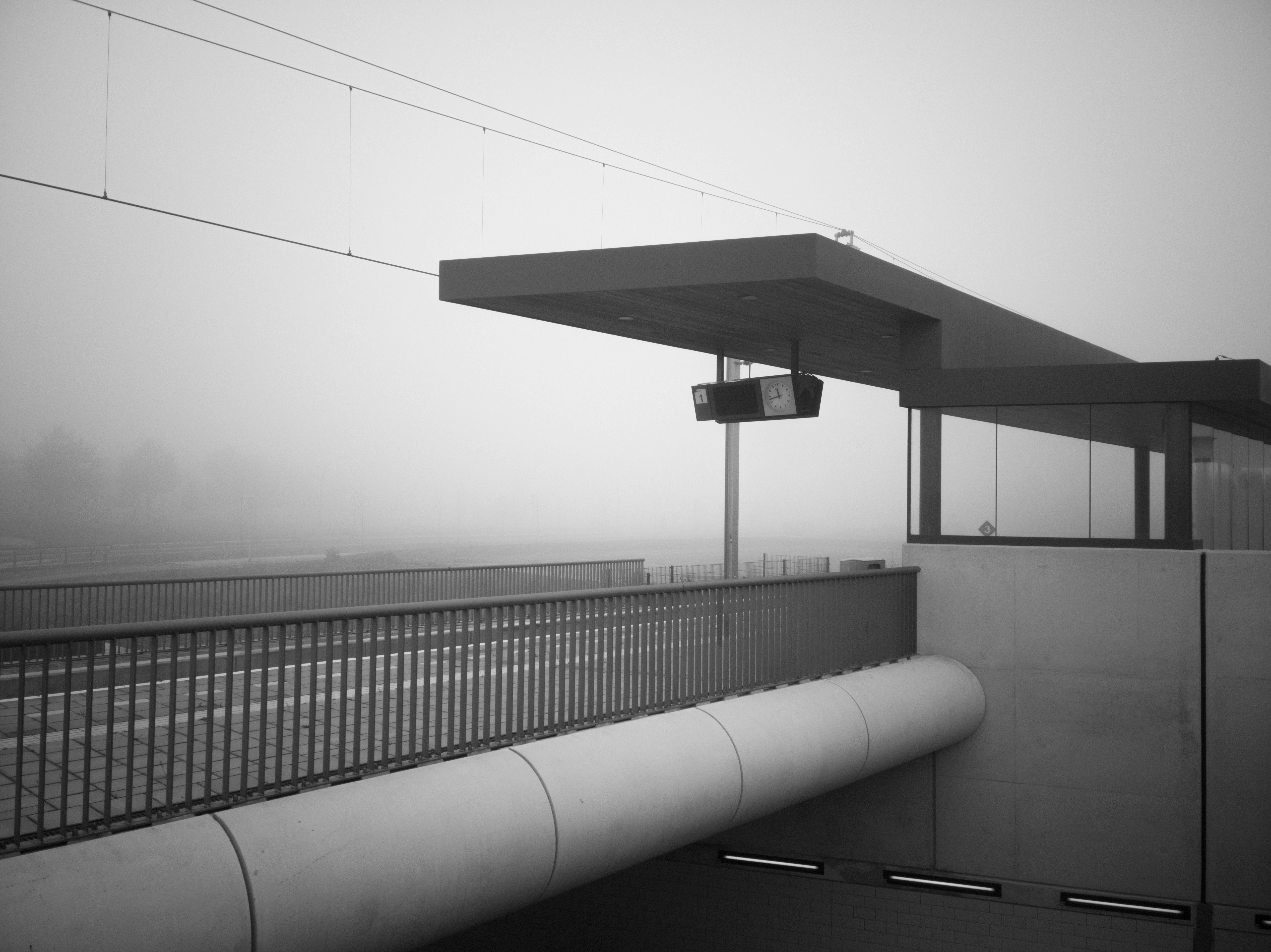 Modern architectural platform shrouded in fog, emphasizing minimalist design and atmospheric depth.