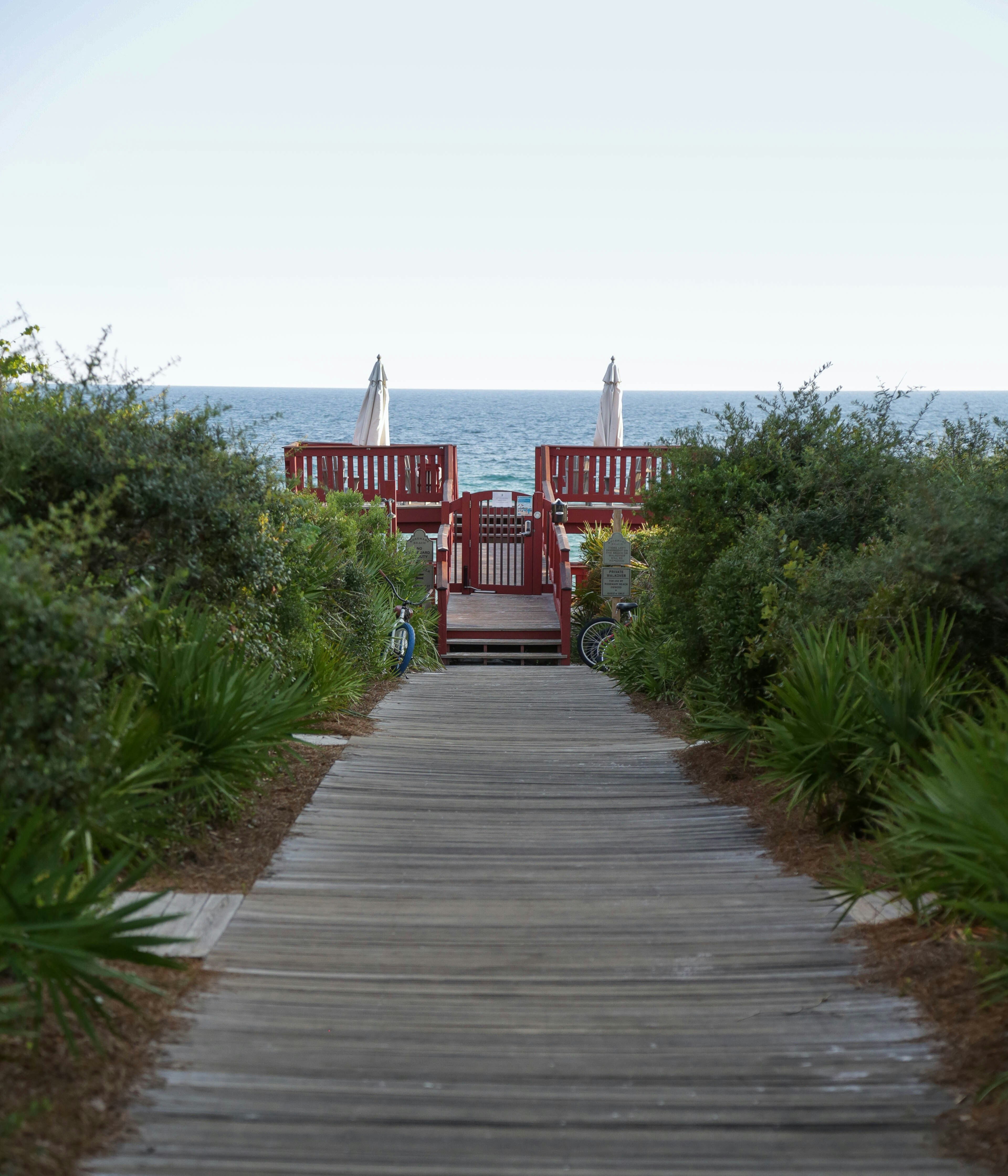 Red Portal to the Sea: Symmetrical Boardwalk Toward the Quiet Horizon