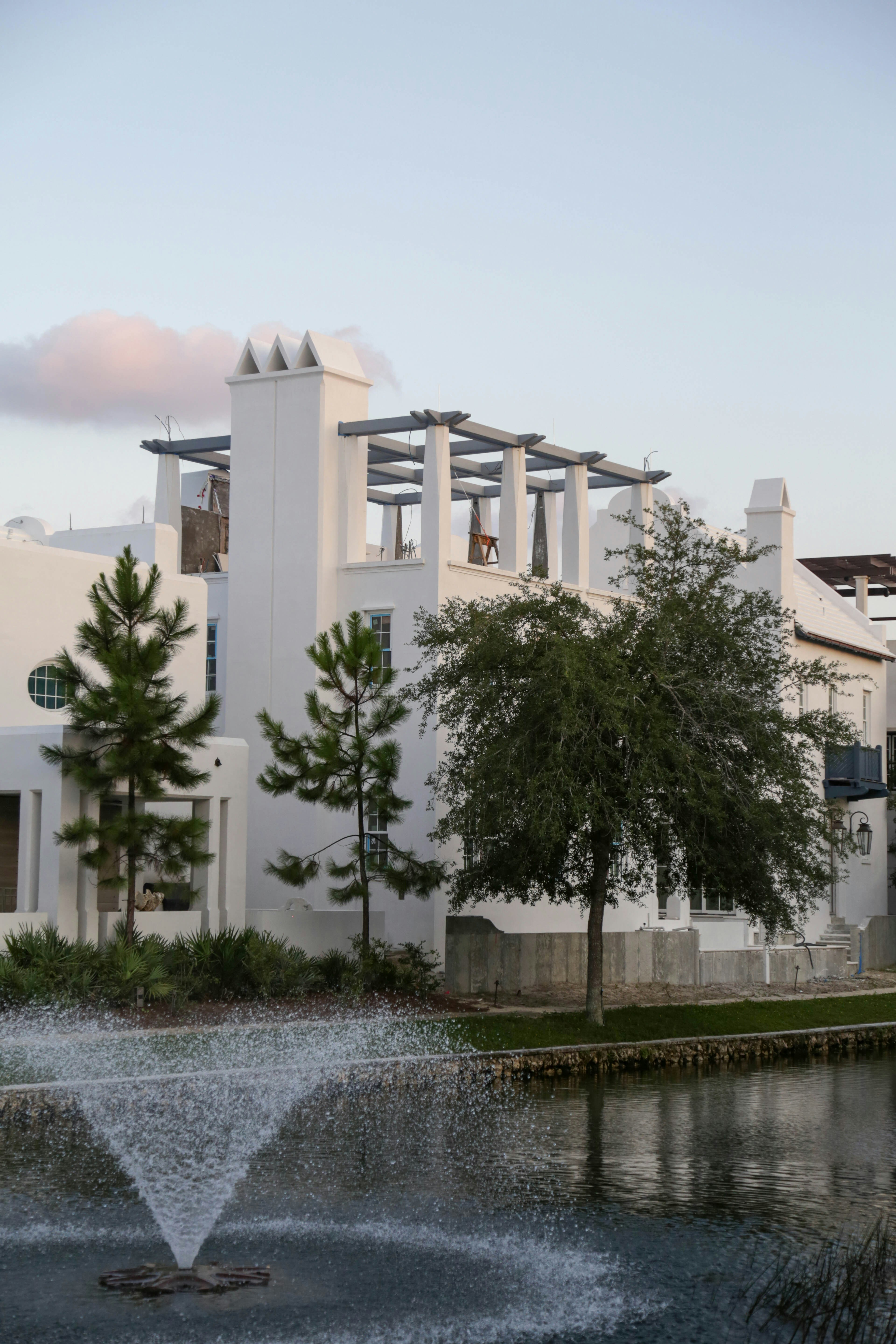 White Terraces by the Canal: Sunlit Geometry and a Quiet Fountain