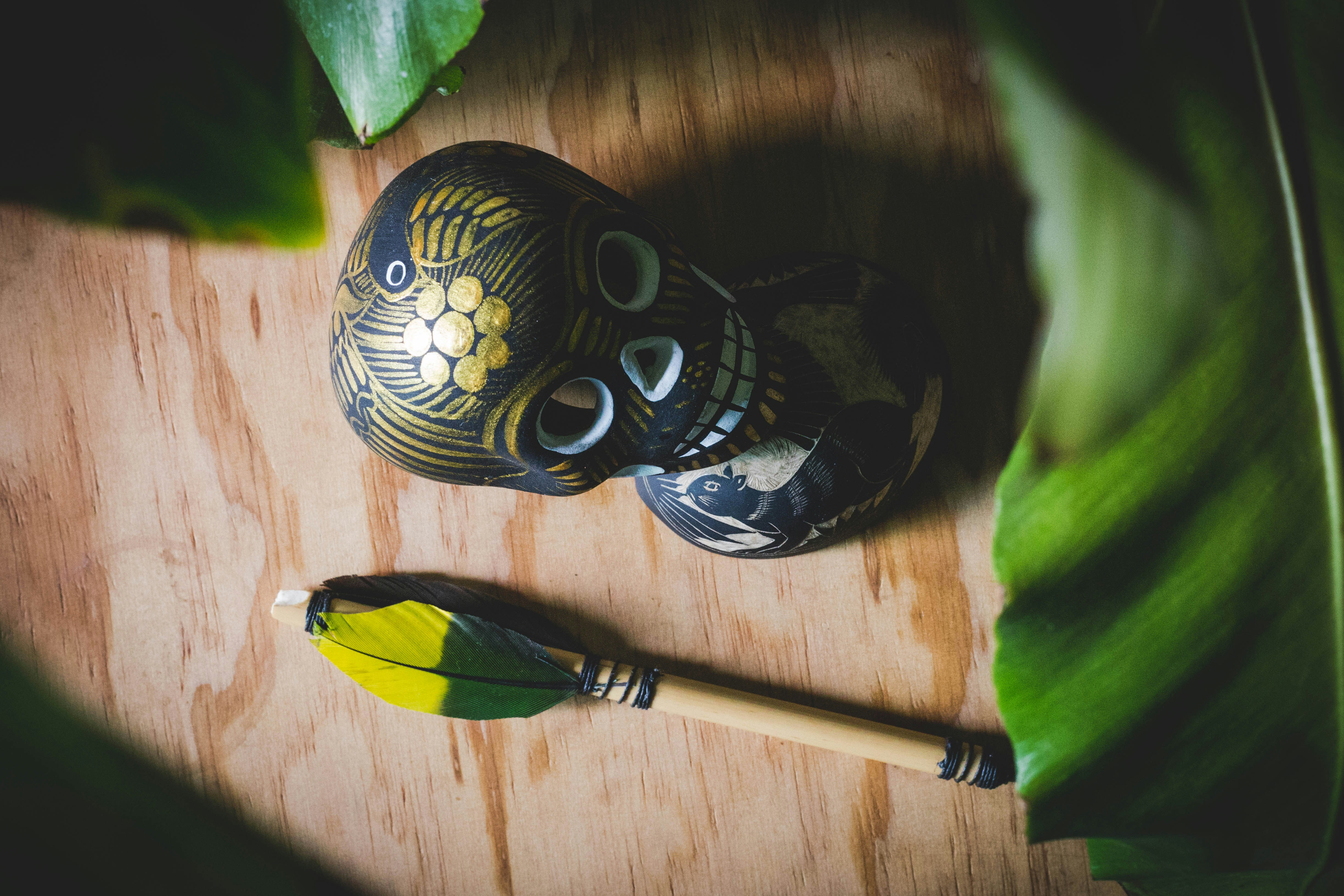 Owl-Patterned Ceramic Mask with a Green-Yellow Brush on Wood