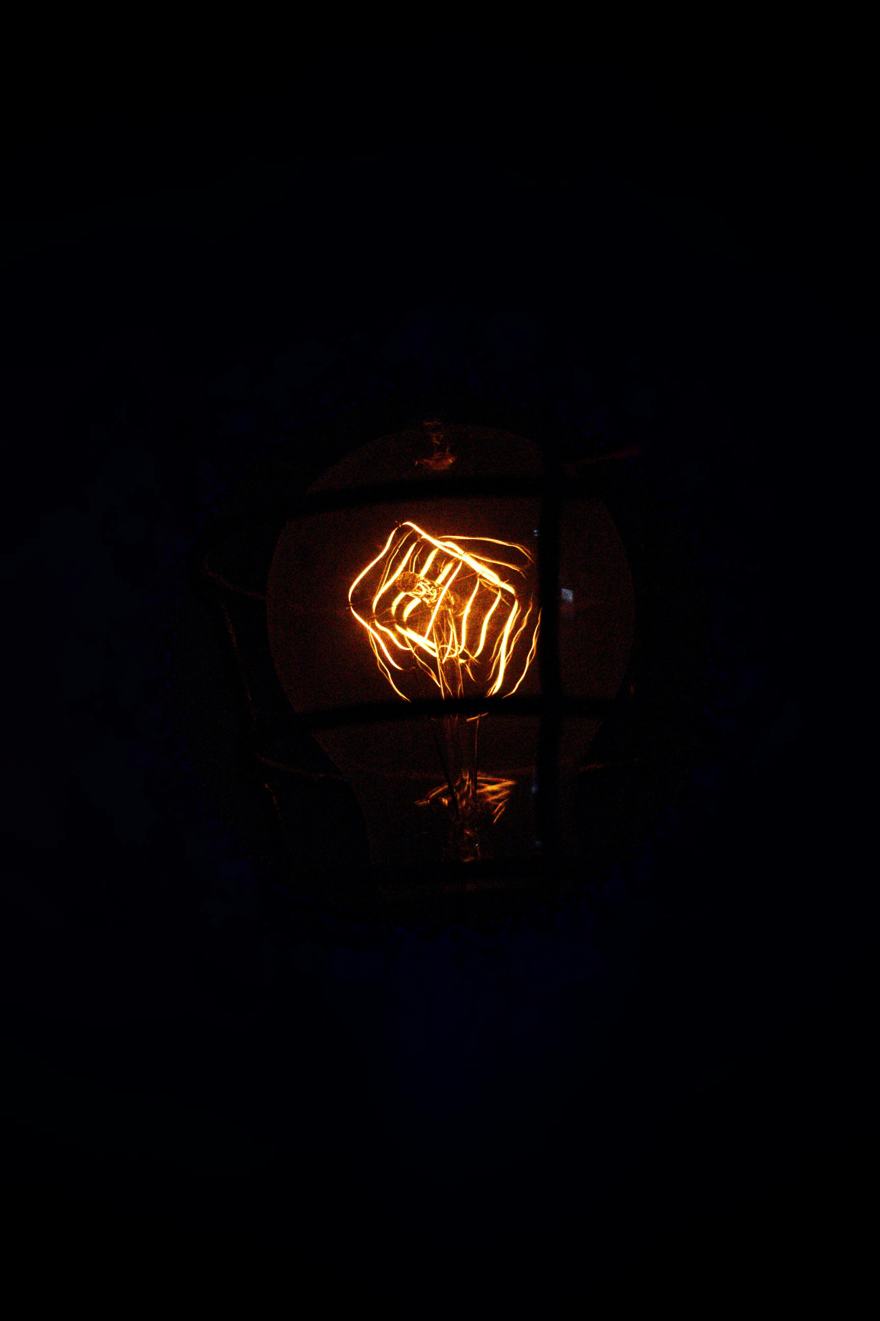 Caged Ember: Warm Edison Glow in a Geometric Frame