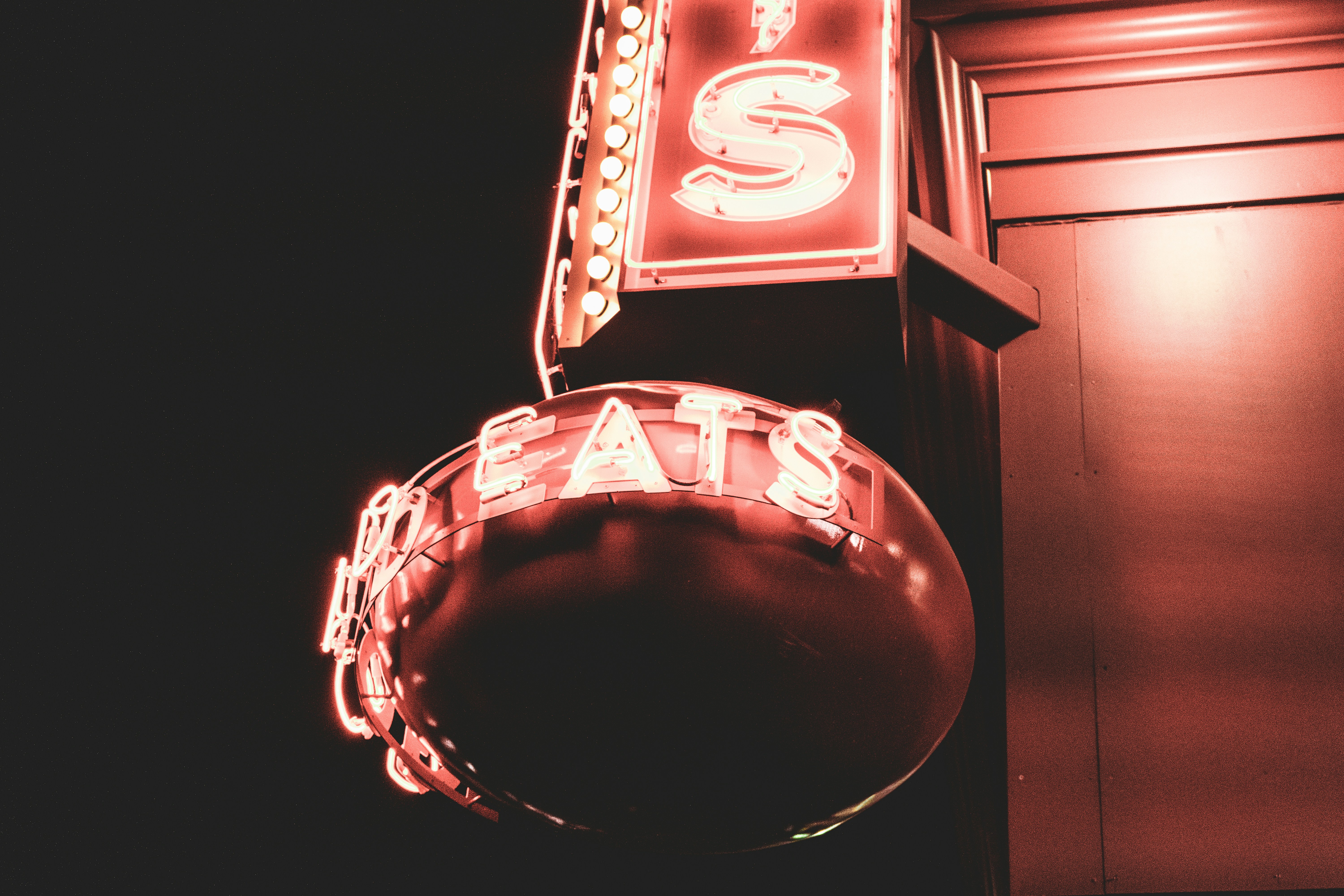 Crimson Neon, Corner Diner: The EATS Sign in Night Glow