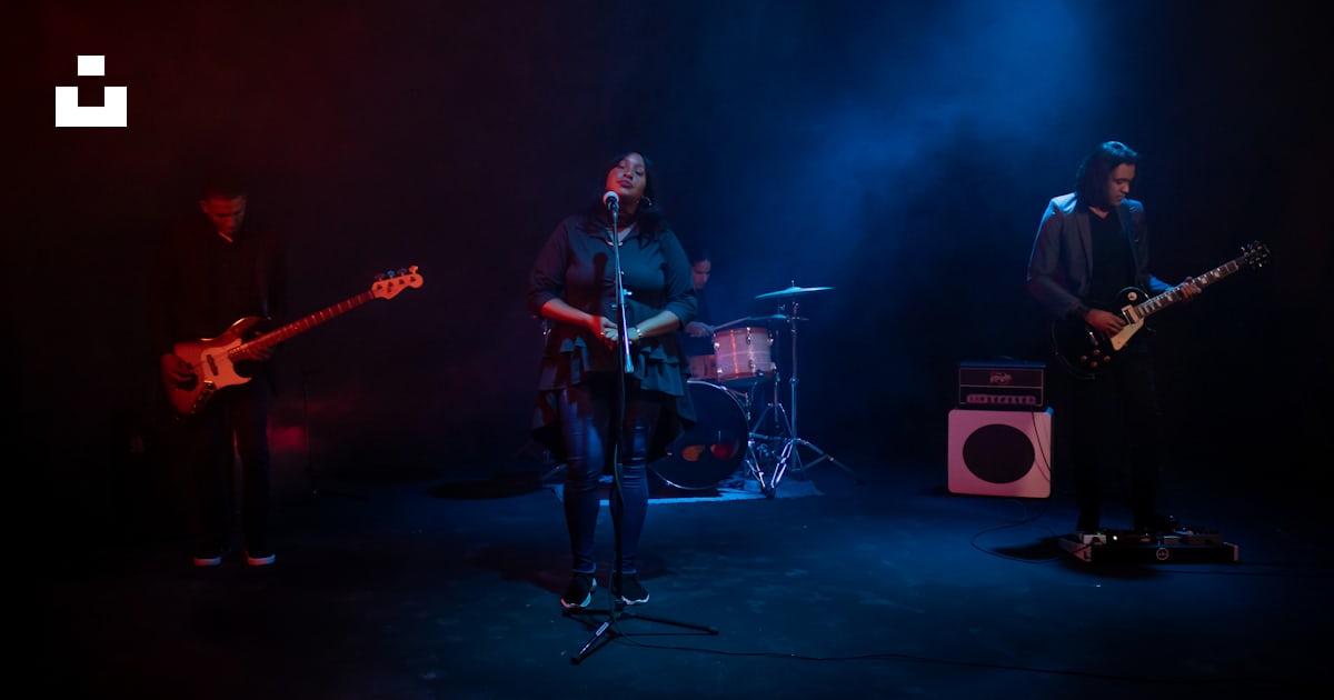 Man In Red Dress Shirt Playing Guitar Photo Free Blue Image On Unsplash