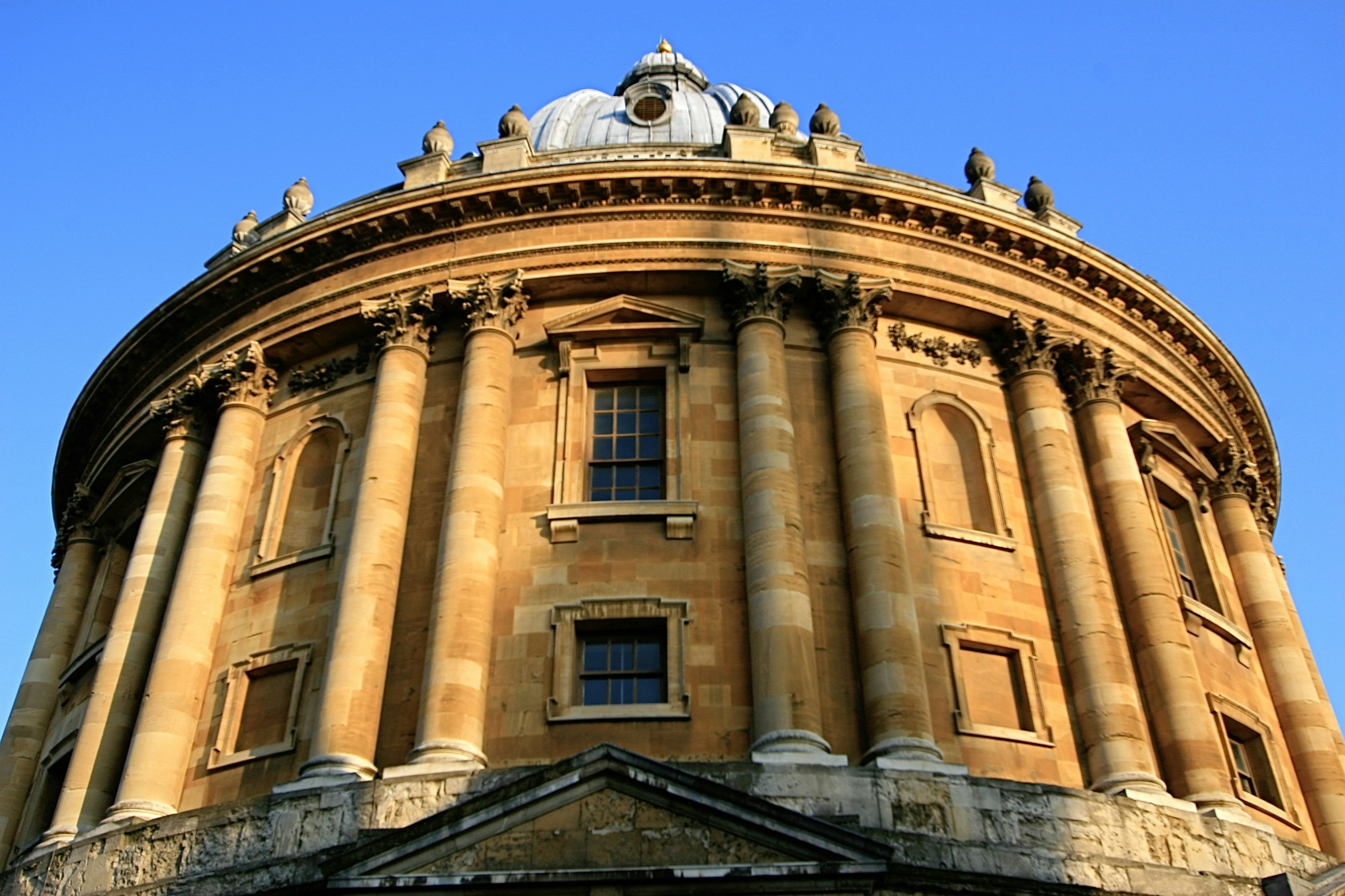 Historic round building with grand columns and a domed roof under a clear blue sky.