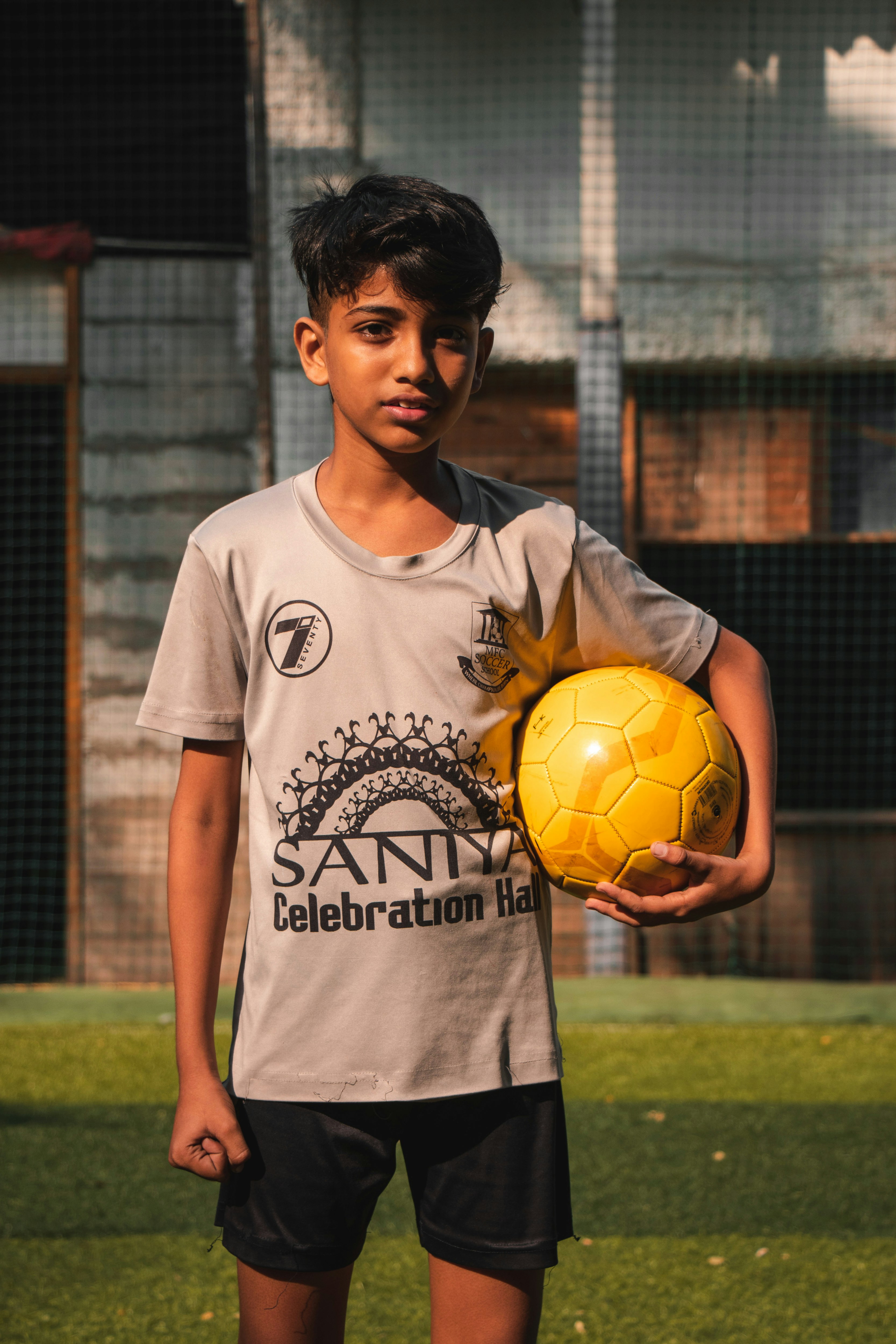 Man in white crew neck t-shirt holding yellow soccer ball photo – Free ...