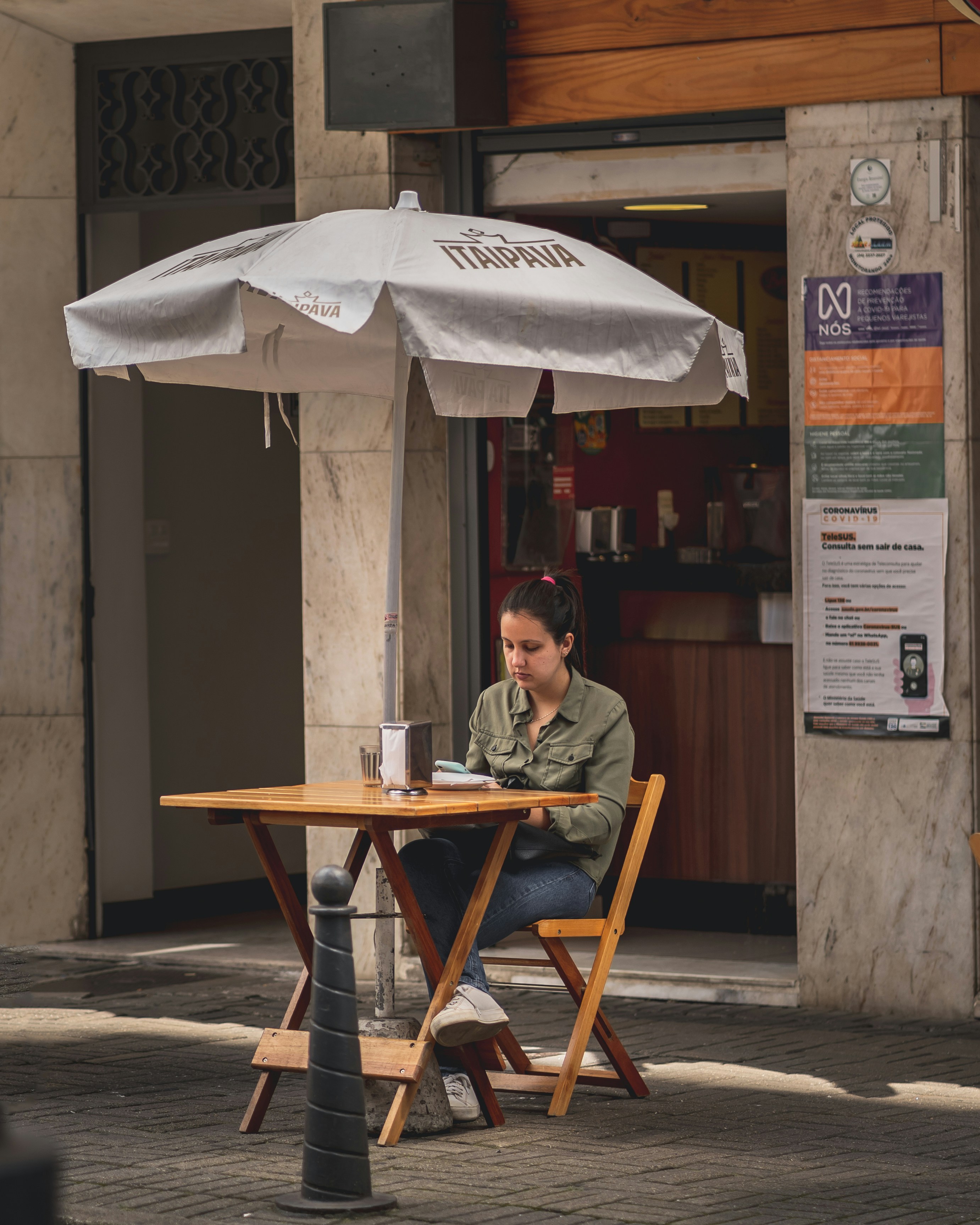 Under the Urban Umbrella: Quiet Focus at a City Café