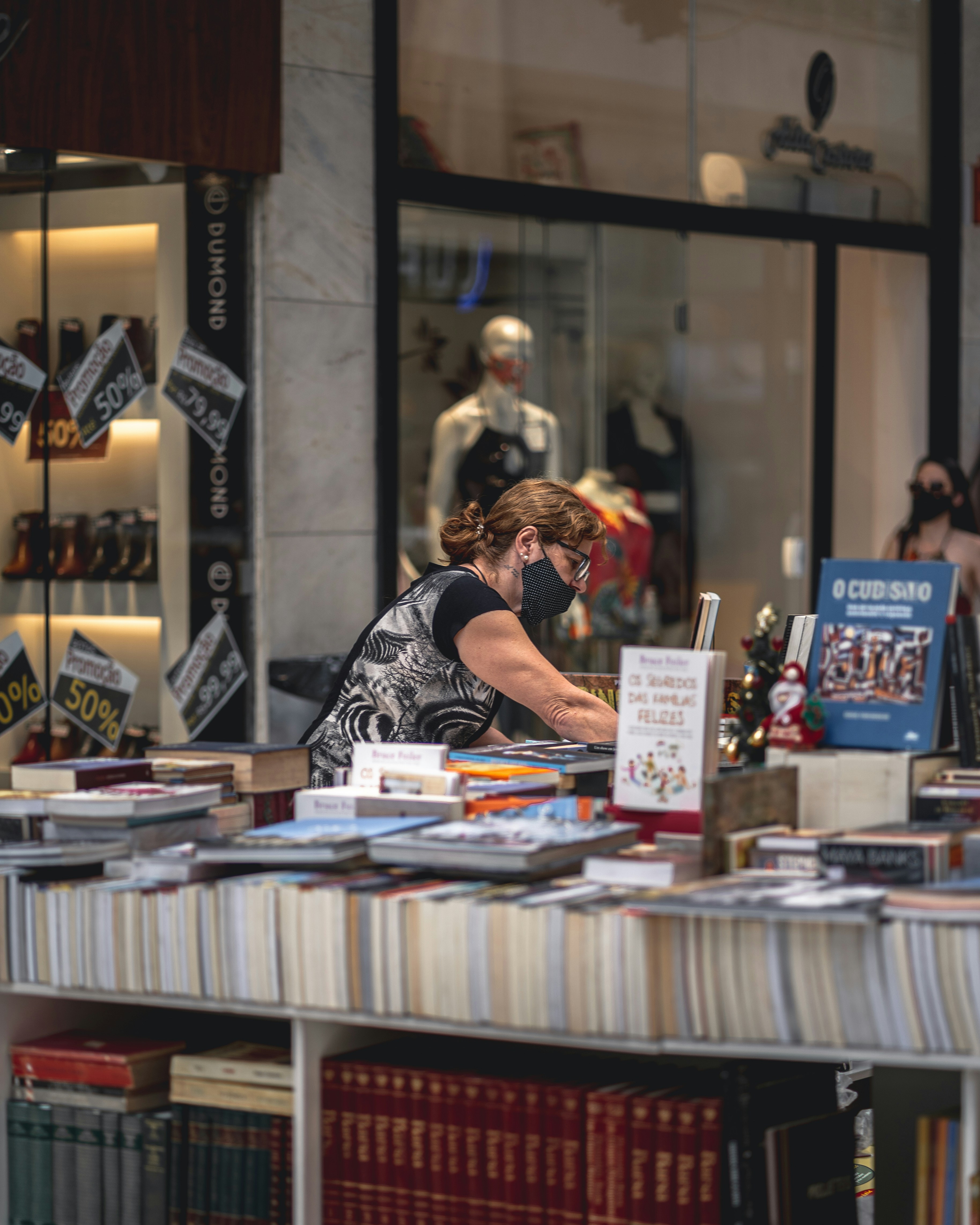 A Quiet Street Bookseller Bent Over the Table