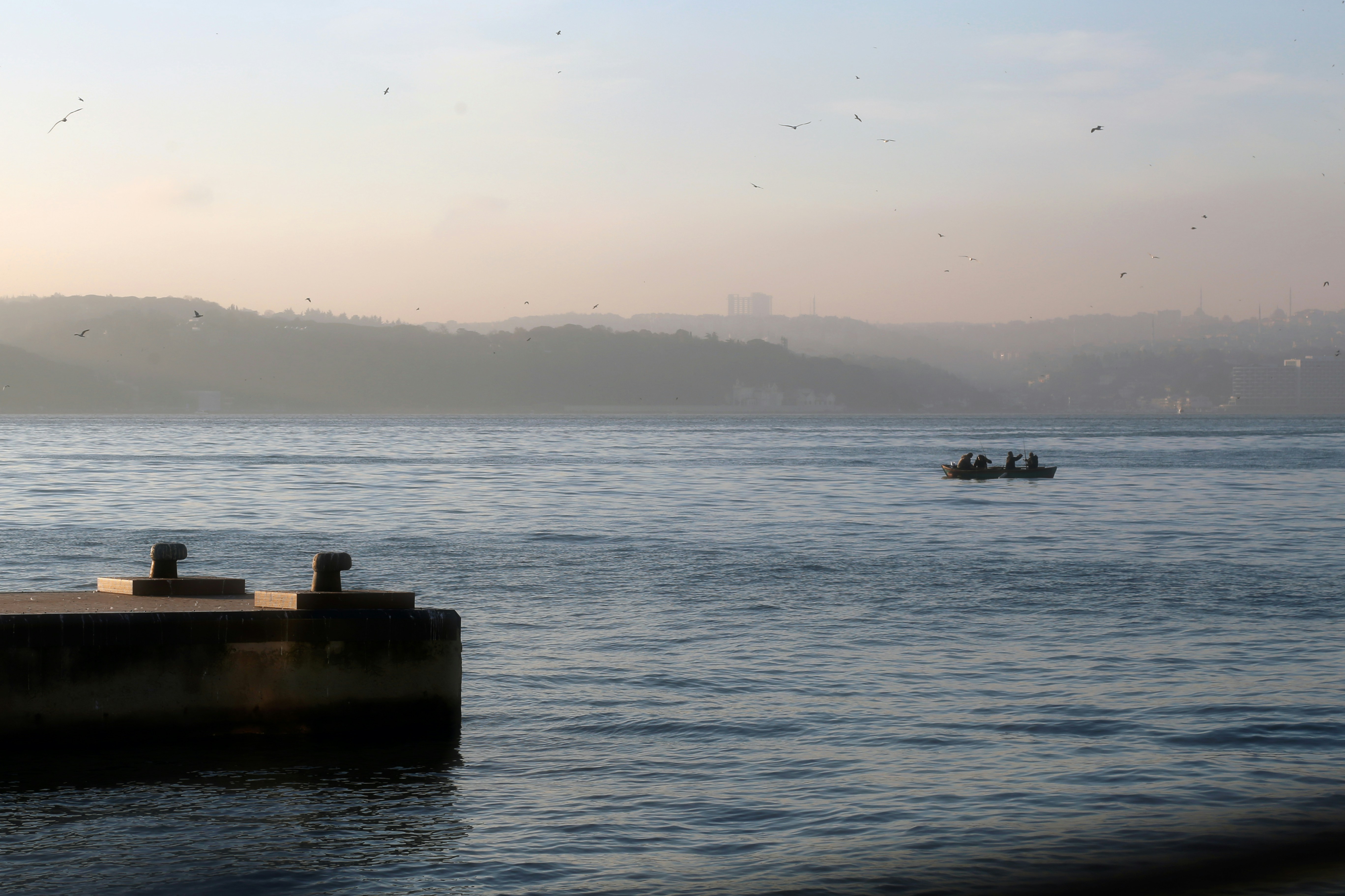 Harbor Dawn: A Distant Boat Drifting Through Quiet Mist