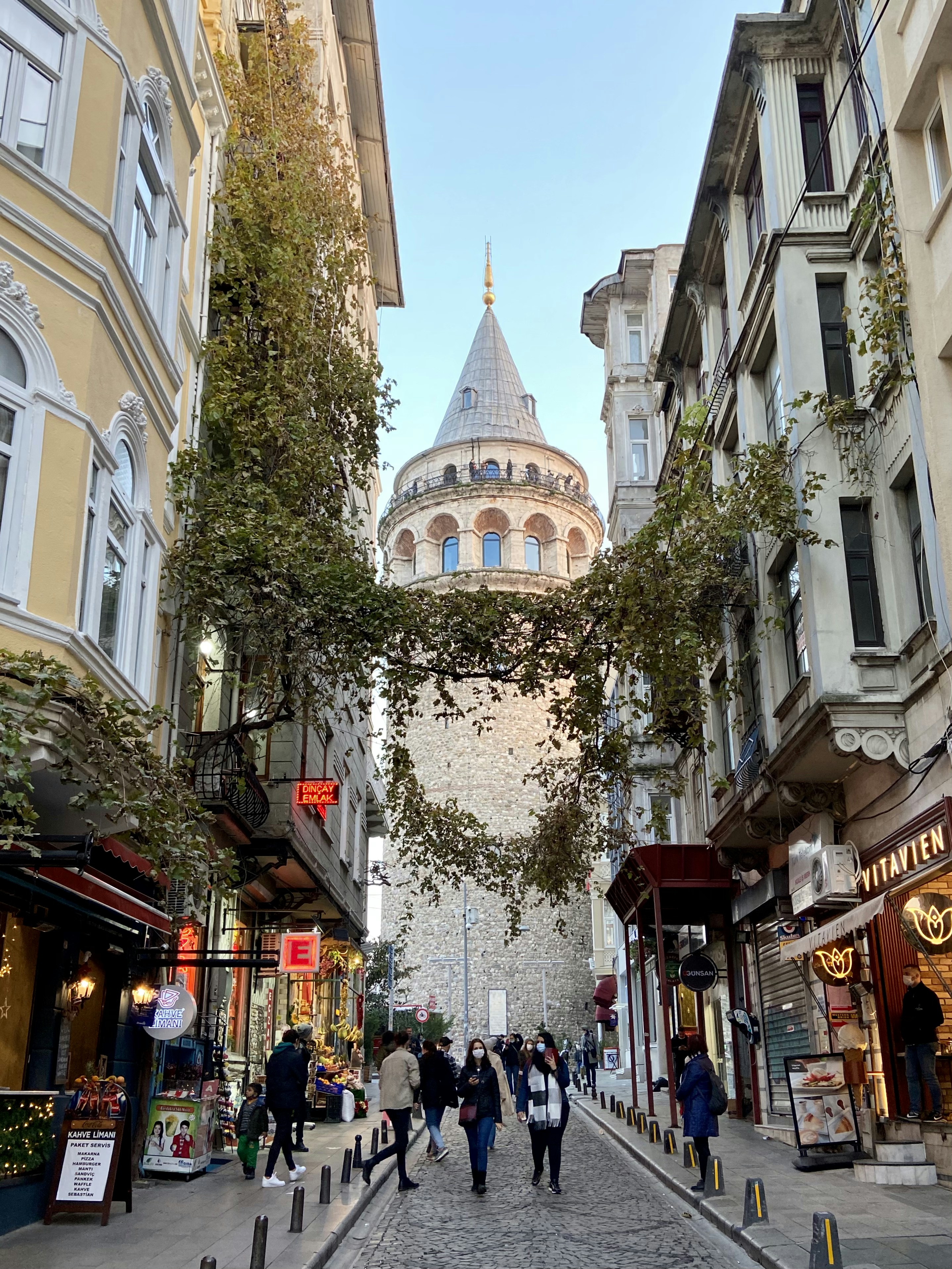 A Glimpse Through Time: The Galata Tower Amidst Urban Life