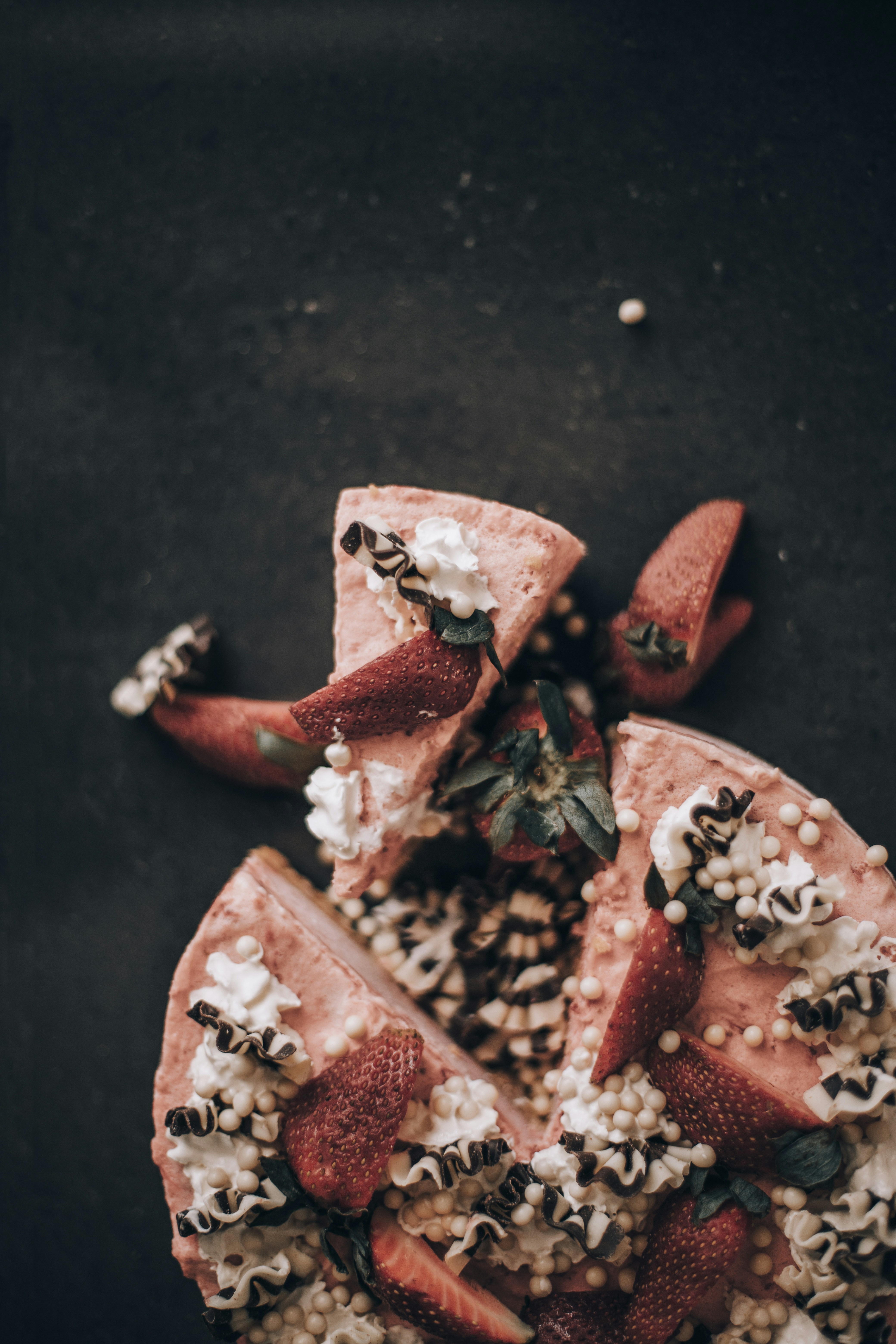 Dessert Mosaic: Pink Strawberry-Topped Pastry on a Velvet Slate