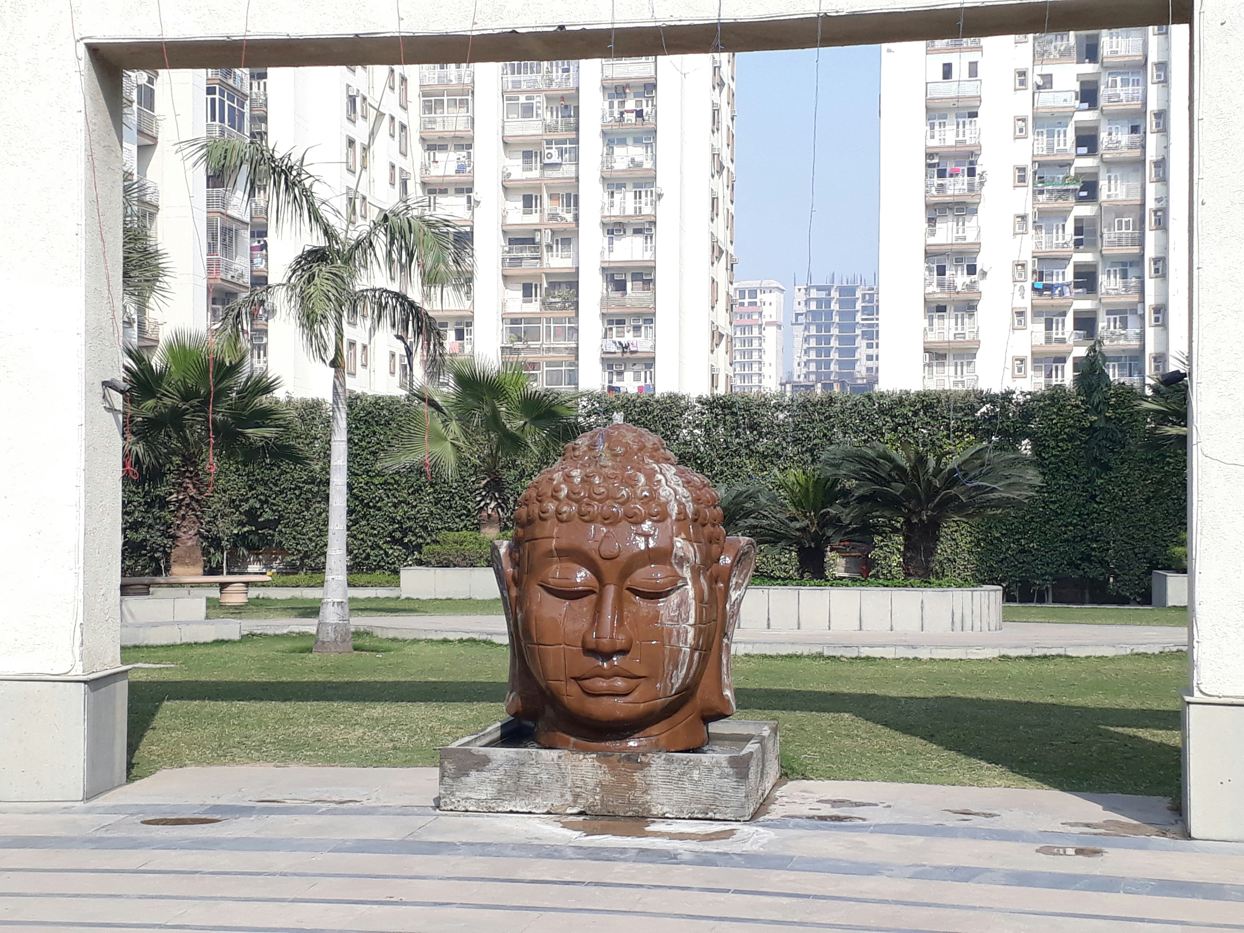 Brown concrete statue near green grass field during daytime photo ...