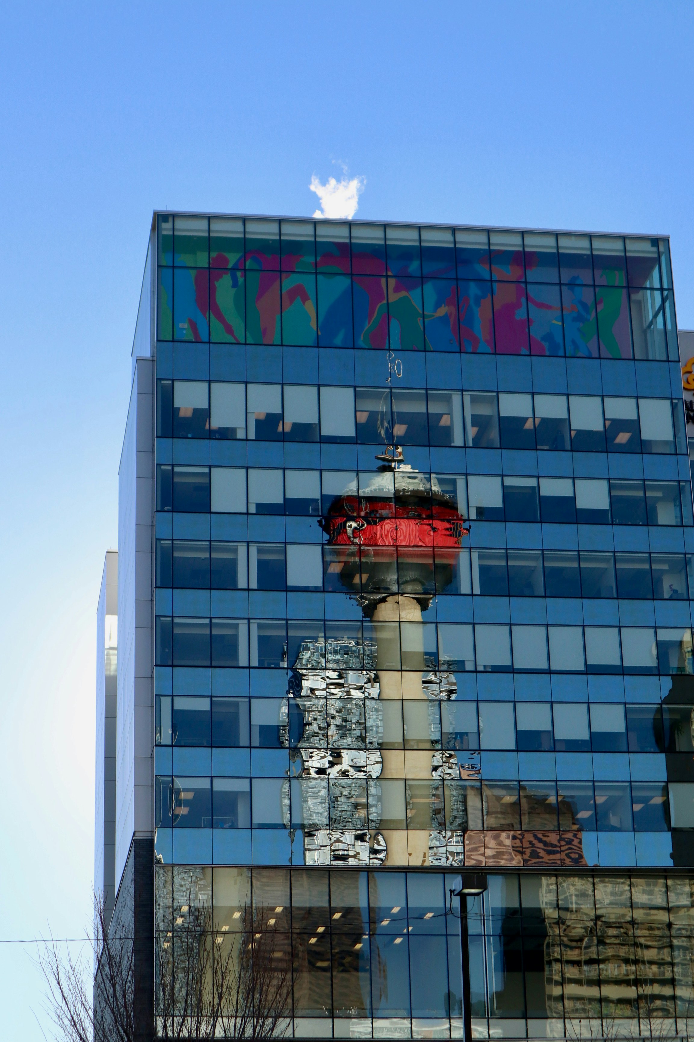 Crimson Spire Reflected in a Glass Facade